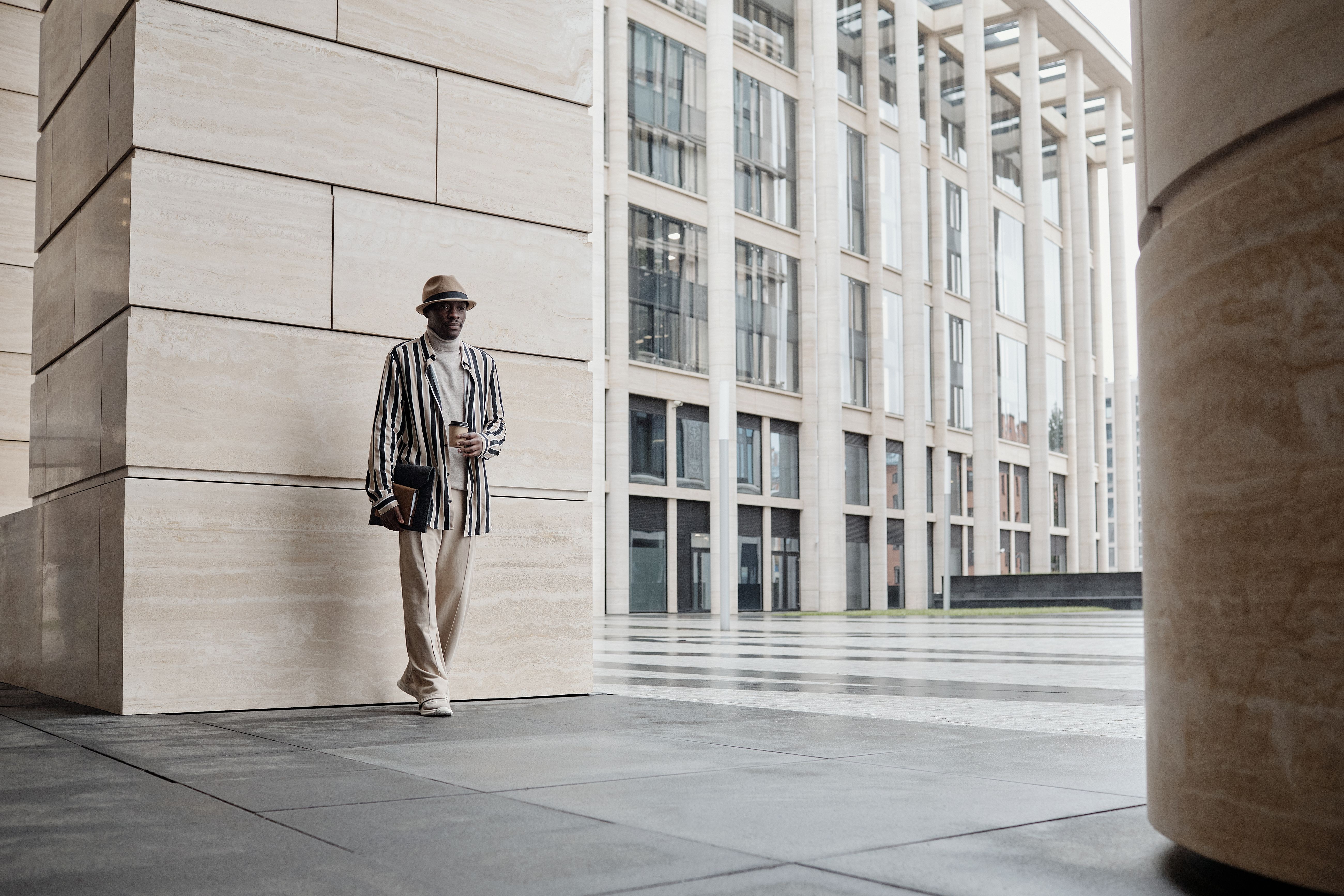 Stylish Man Standing in Front of a Wall · Free Stock Photo