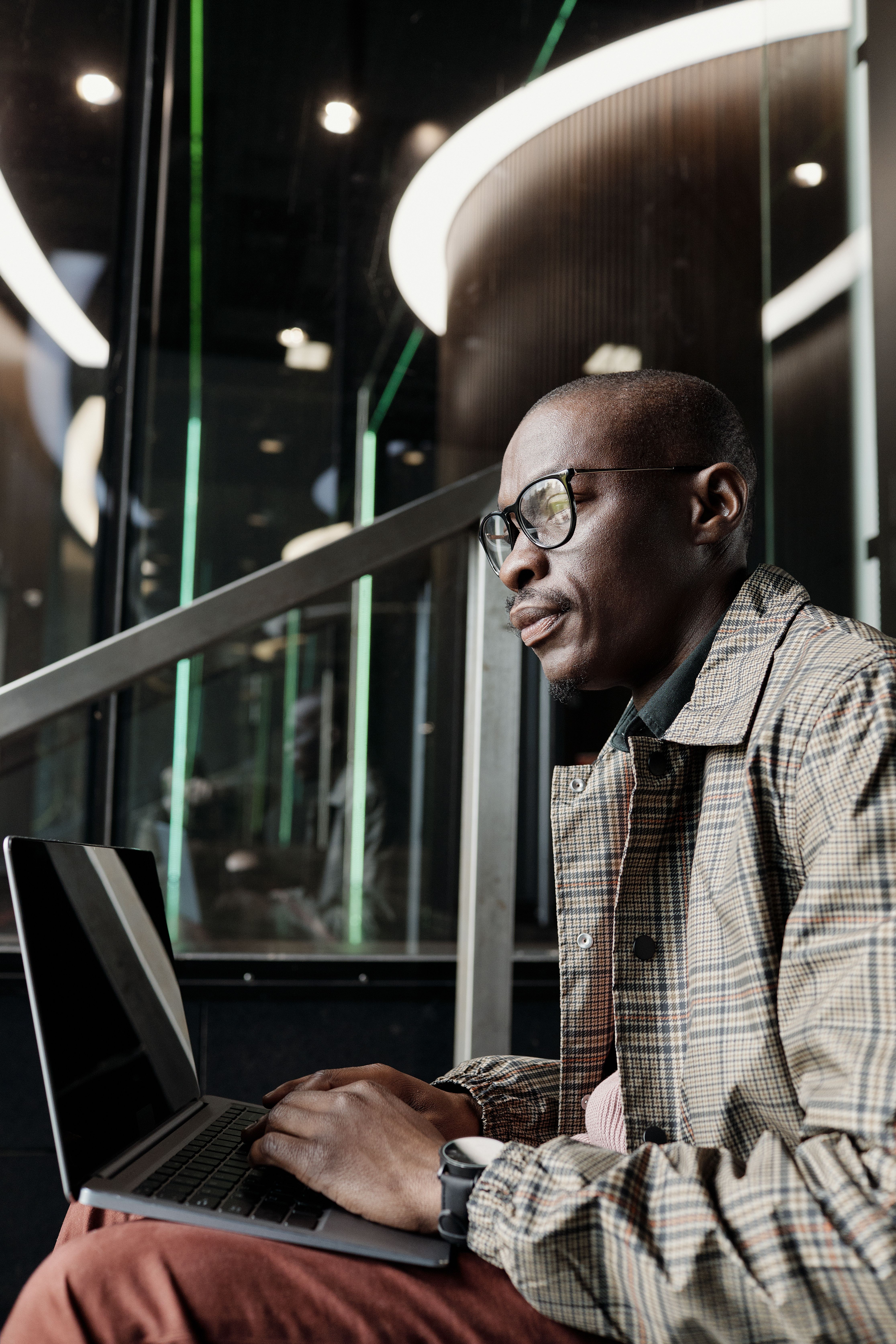 A Stylish Businessman Using a Laptop · Free Stock Photo