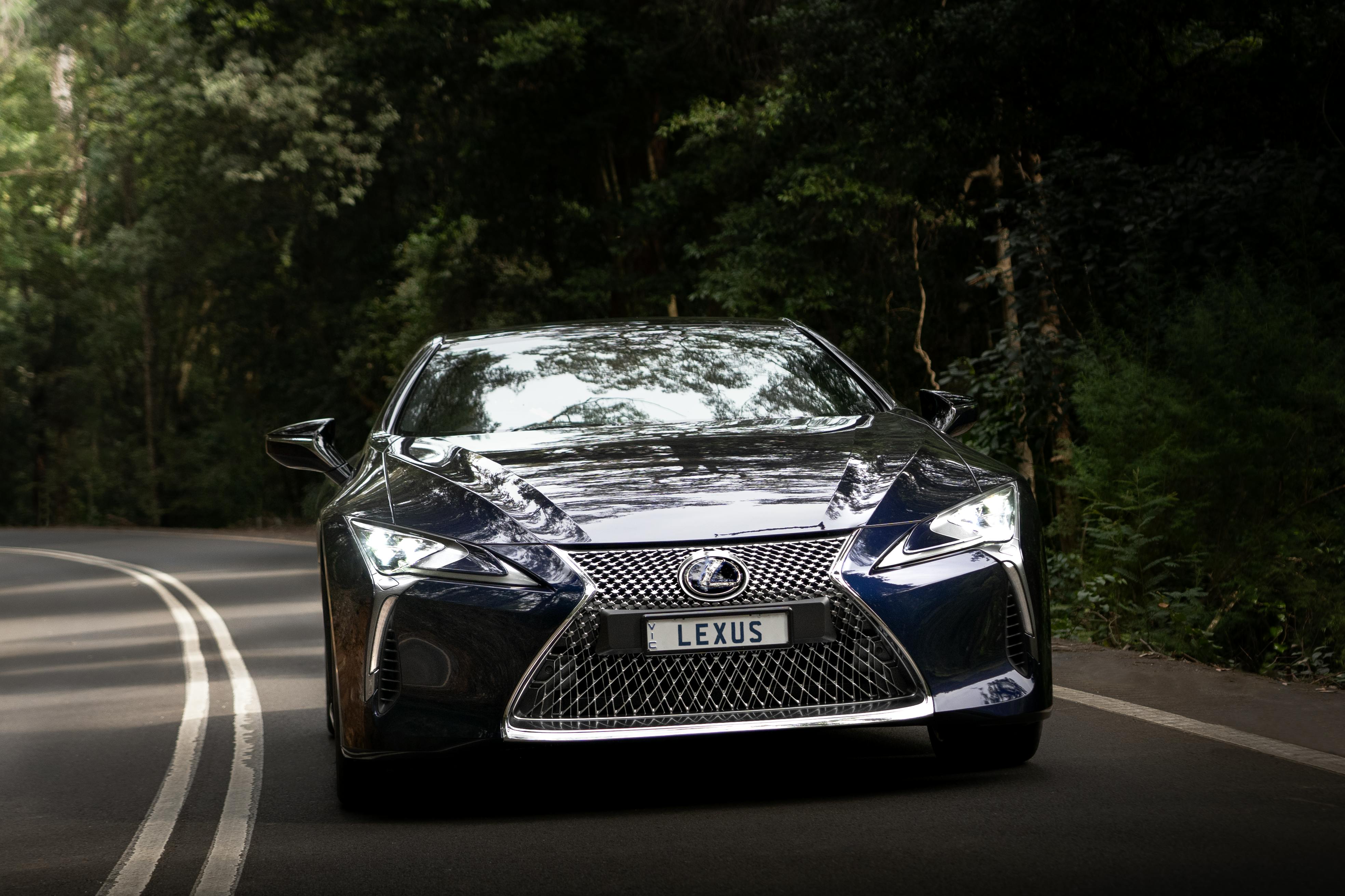 Lexus Car Driving on Forest Road · Free Stock Photo