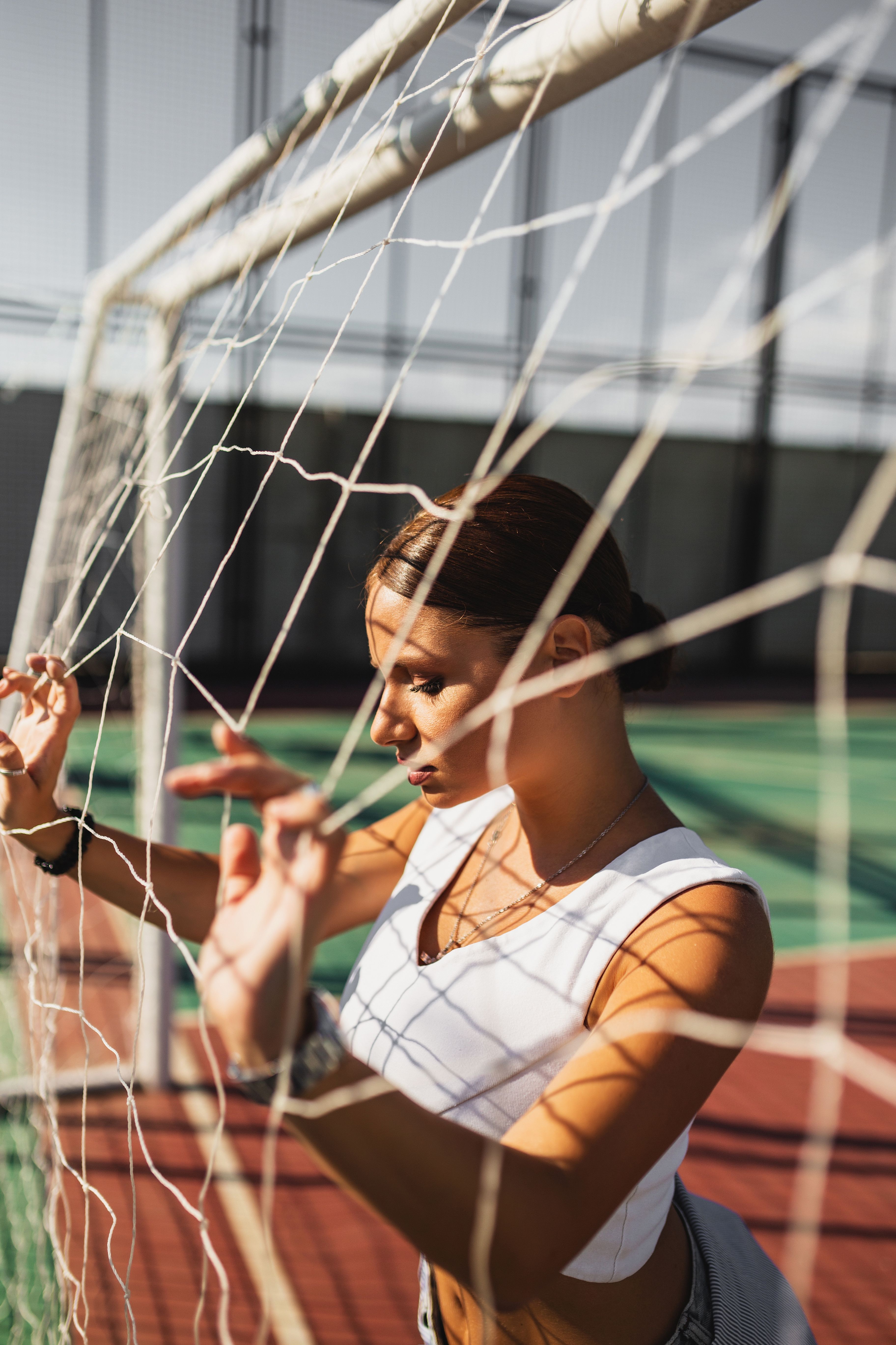 Beautiful Woman holding the Net of a Goal Post · Free Stock Photo