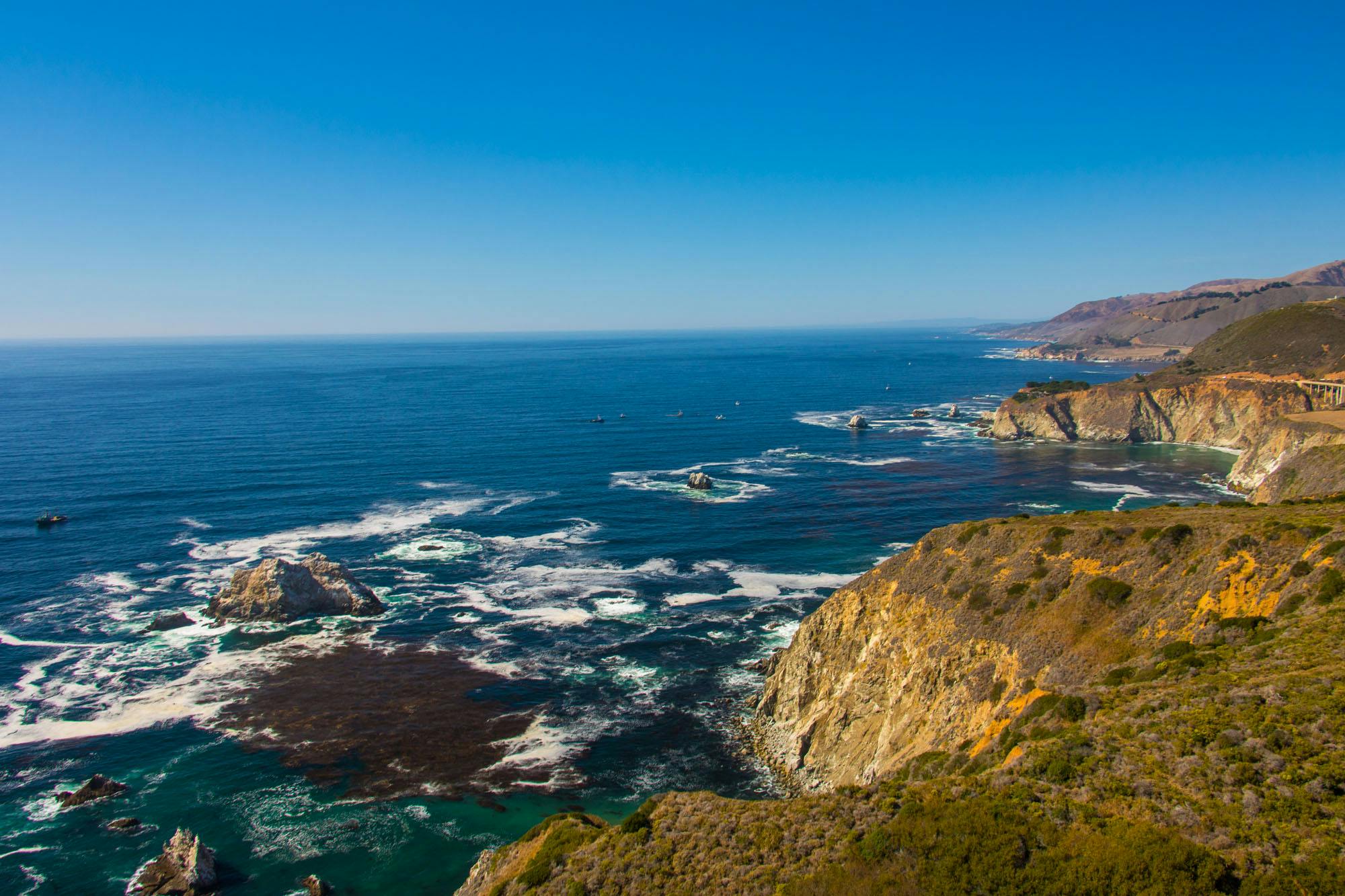 Brown Rock Plateau Beside Body of Water · Free Stock Photo