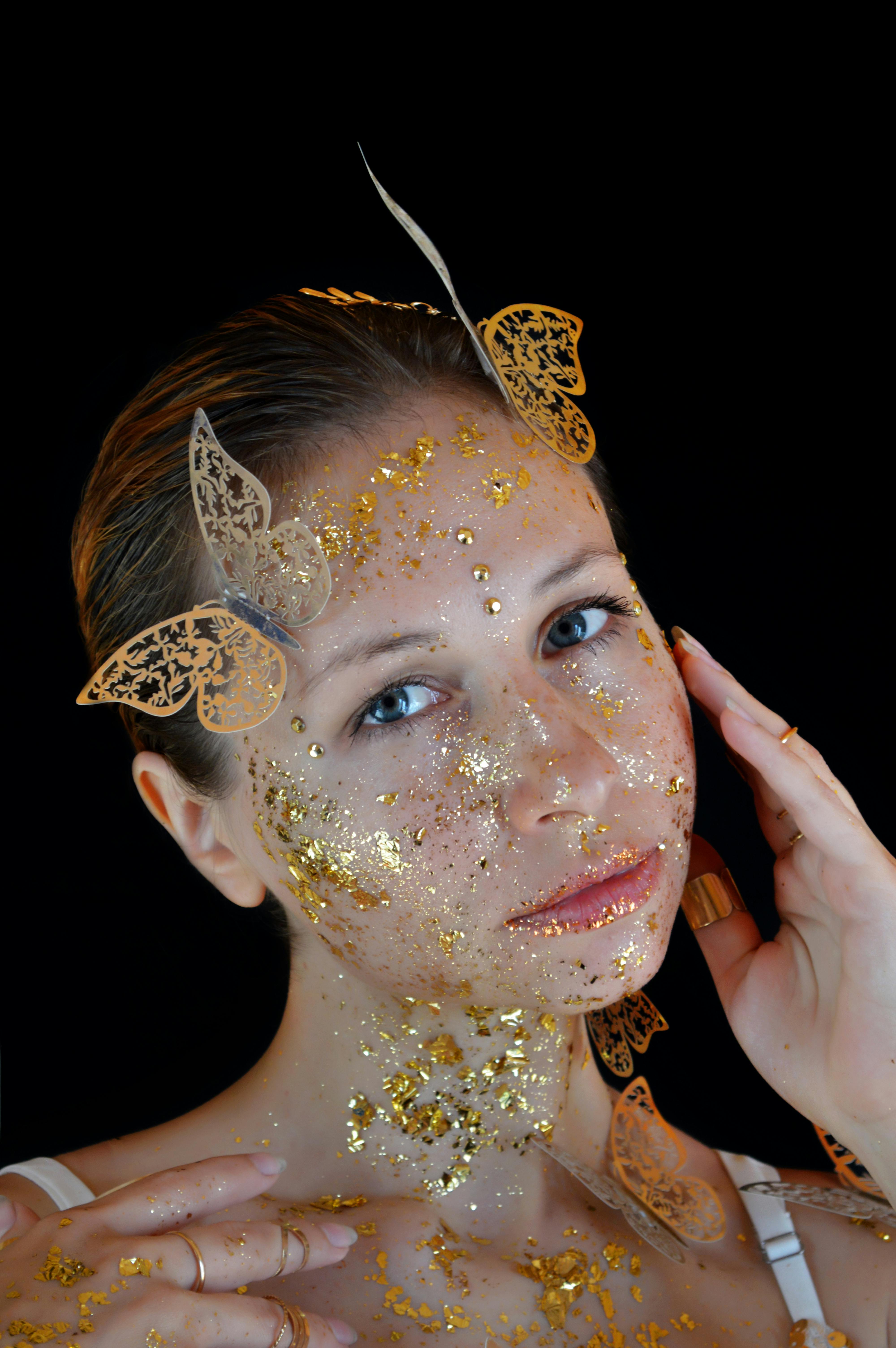 Woman with golden leaf makeup and artificial butterflies on head · Free ...