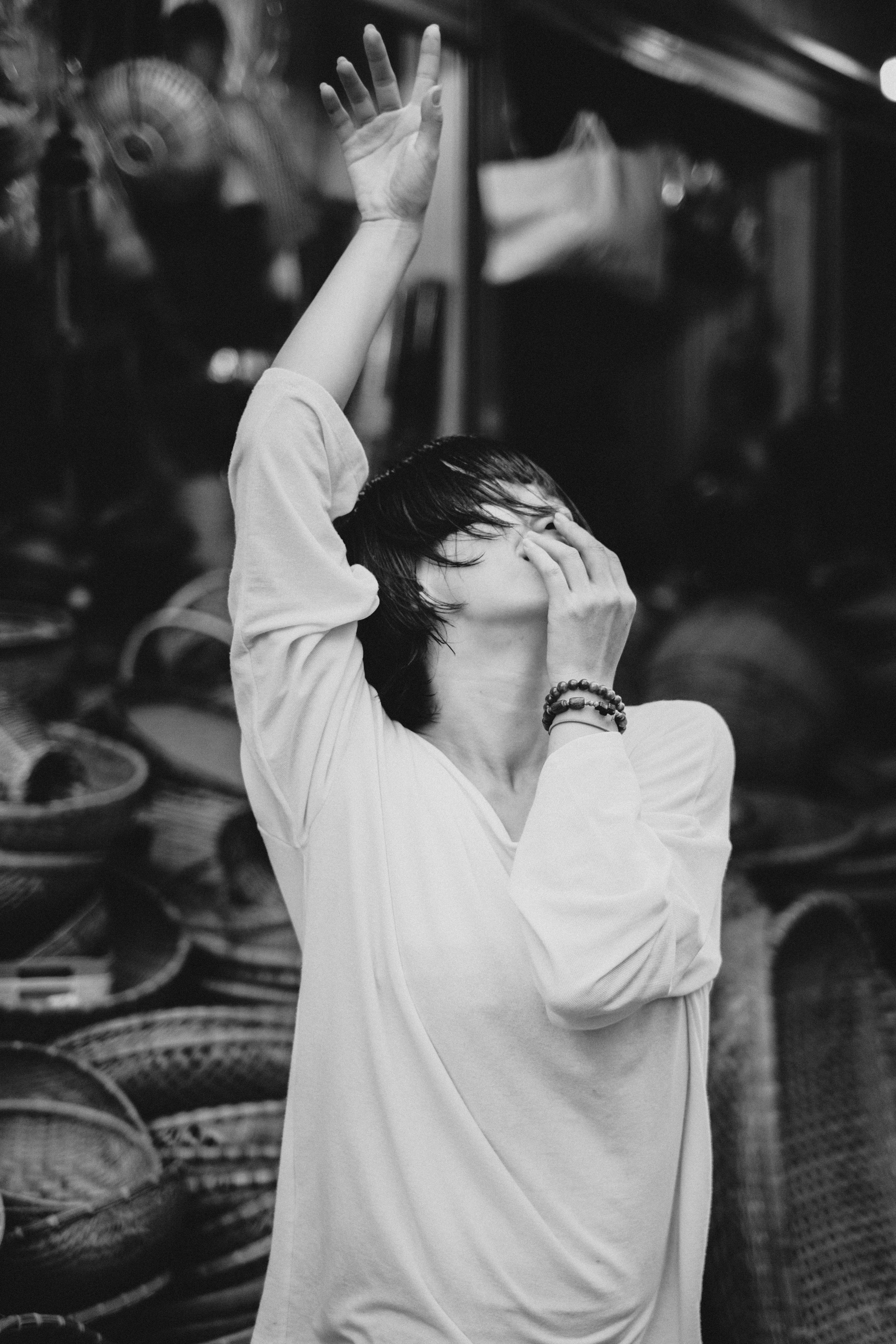 Peaceful gentle female with hand raised on street · Free Stock Photo