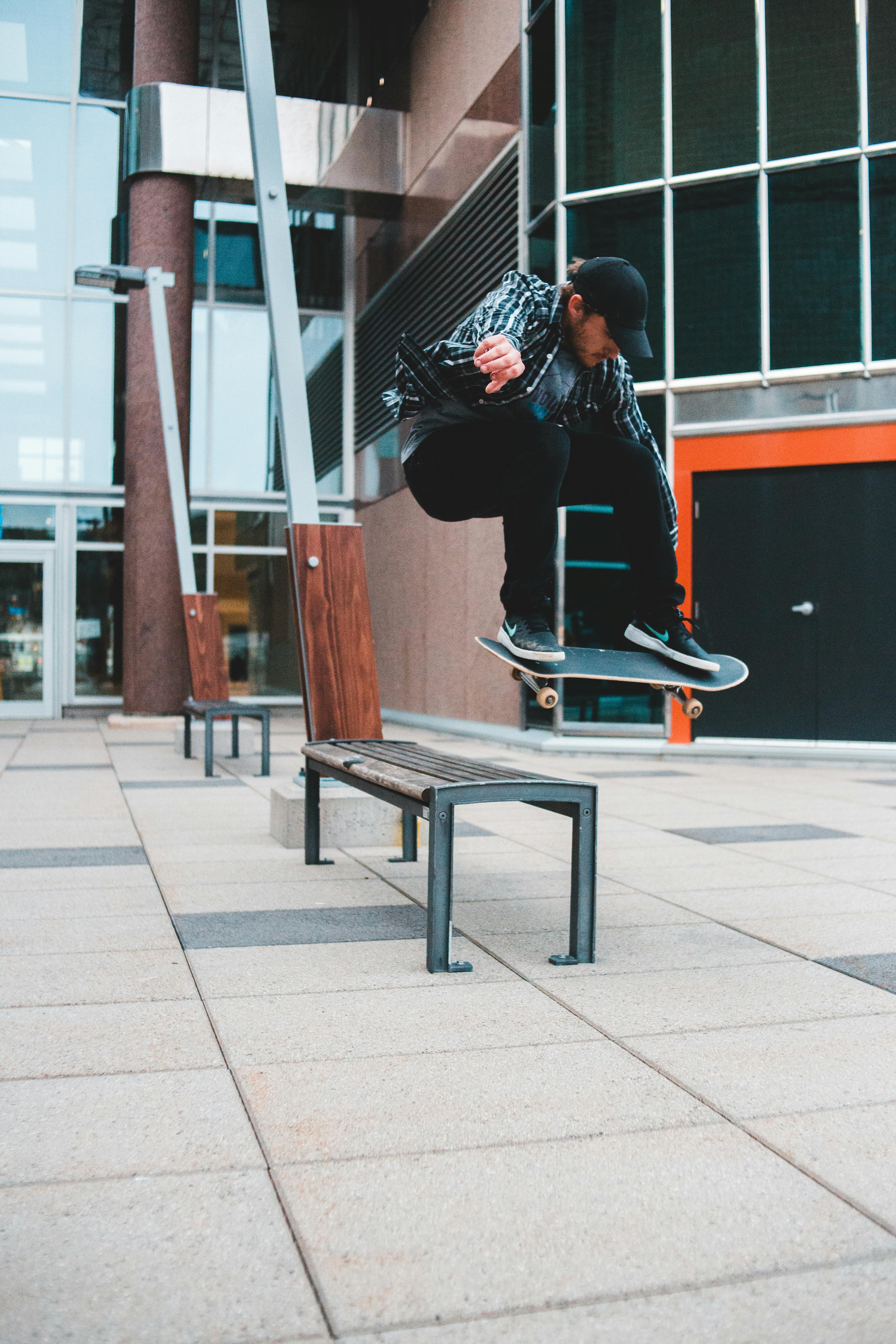 Crop skater jumping on skateboard · Free Stock Photo