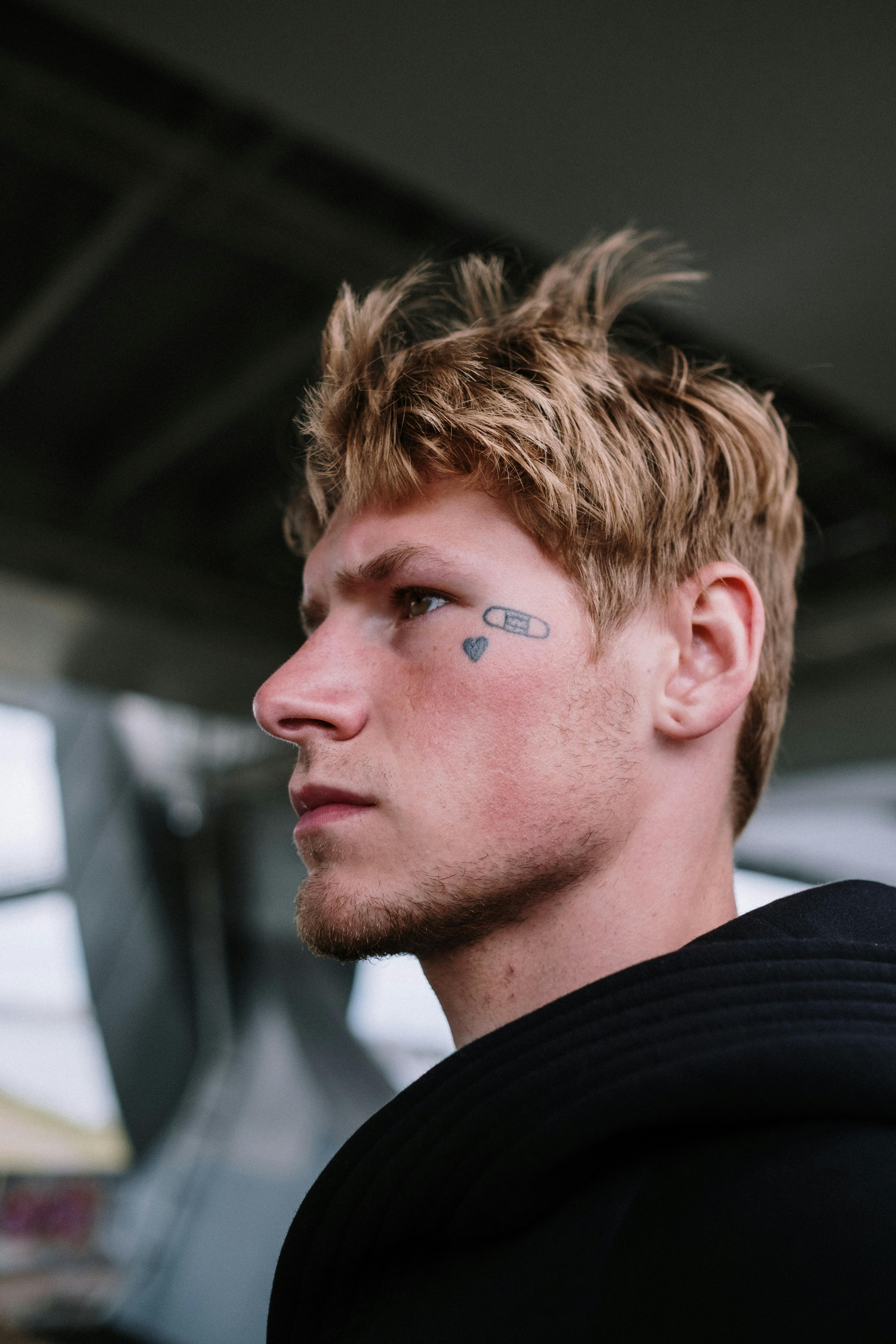 Side View of a Handsome Man with Face Tattoos · Free Stock Photo