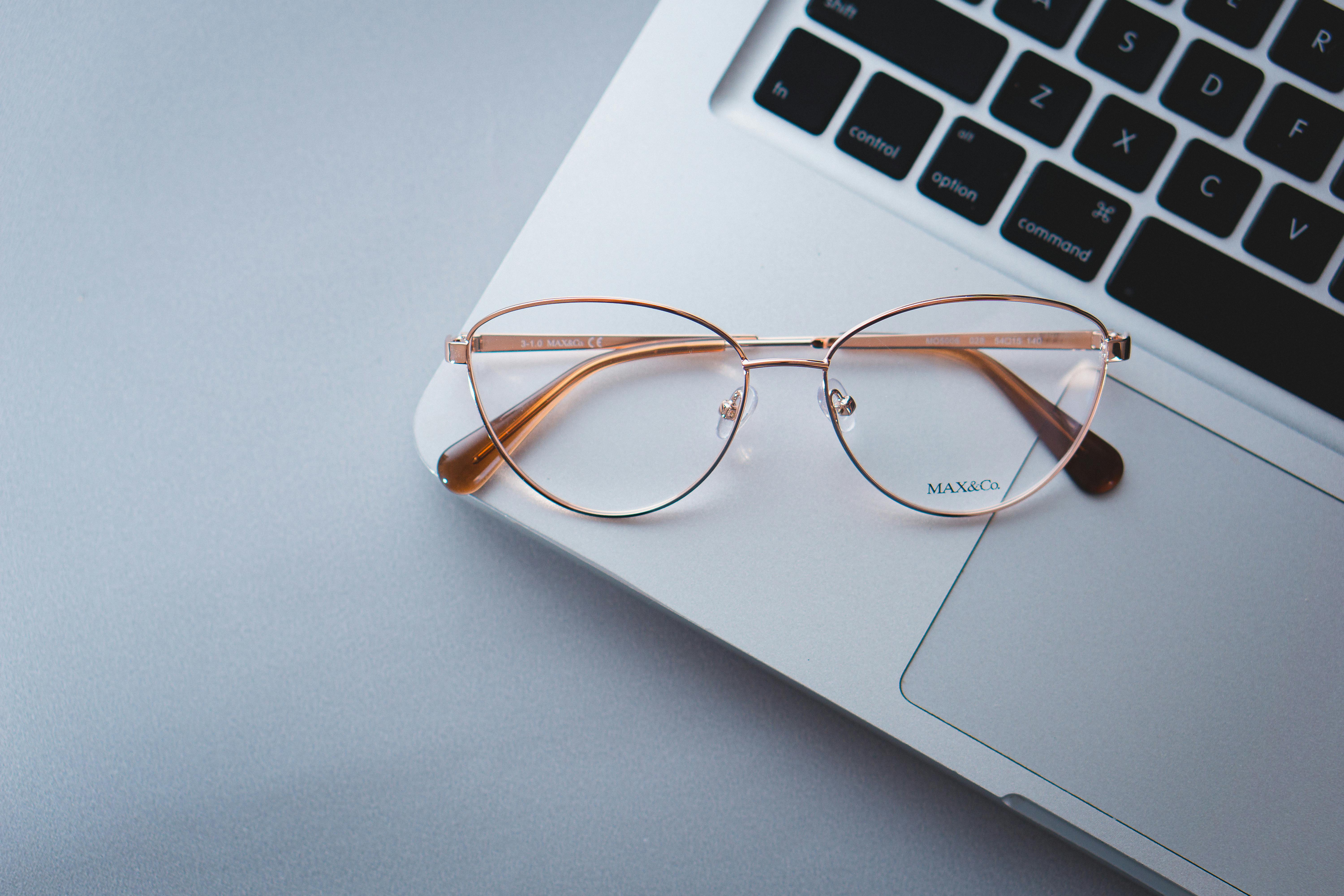 Close-Up Shot of Eyeglasses on a Laptop · Free Stock Photo