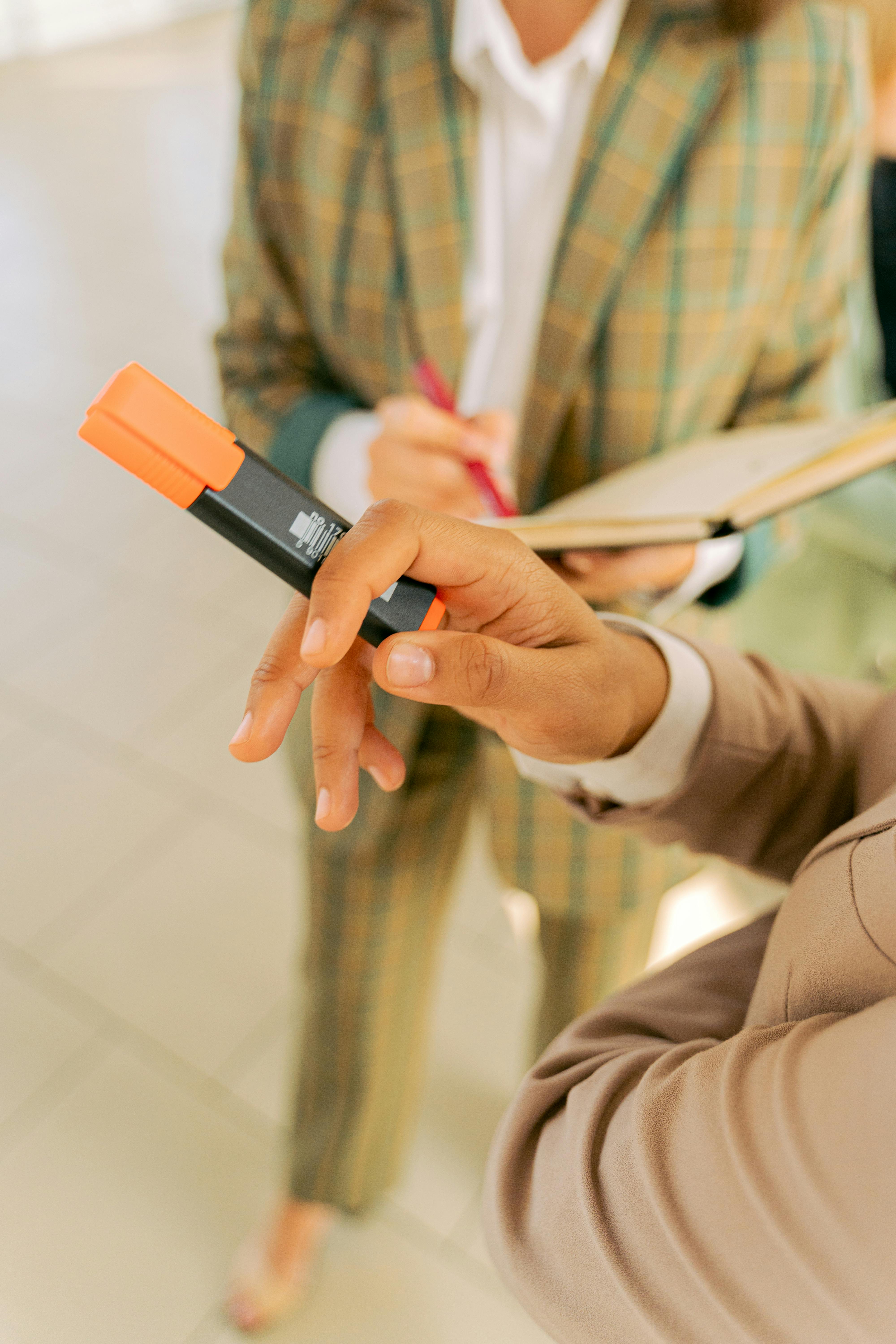 Orange Highlighter held by a Person · Free Stock Photo