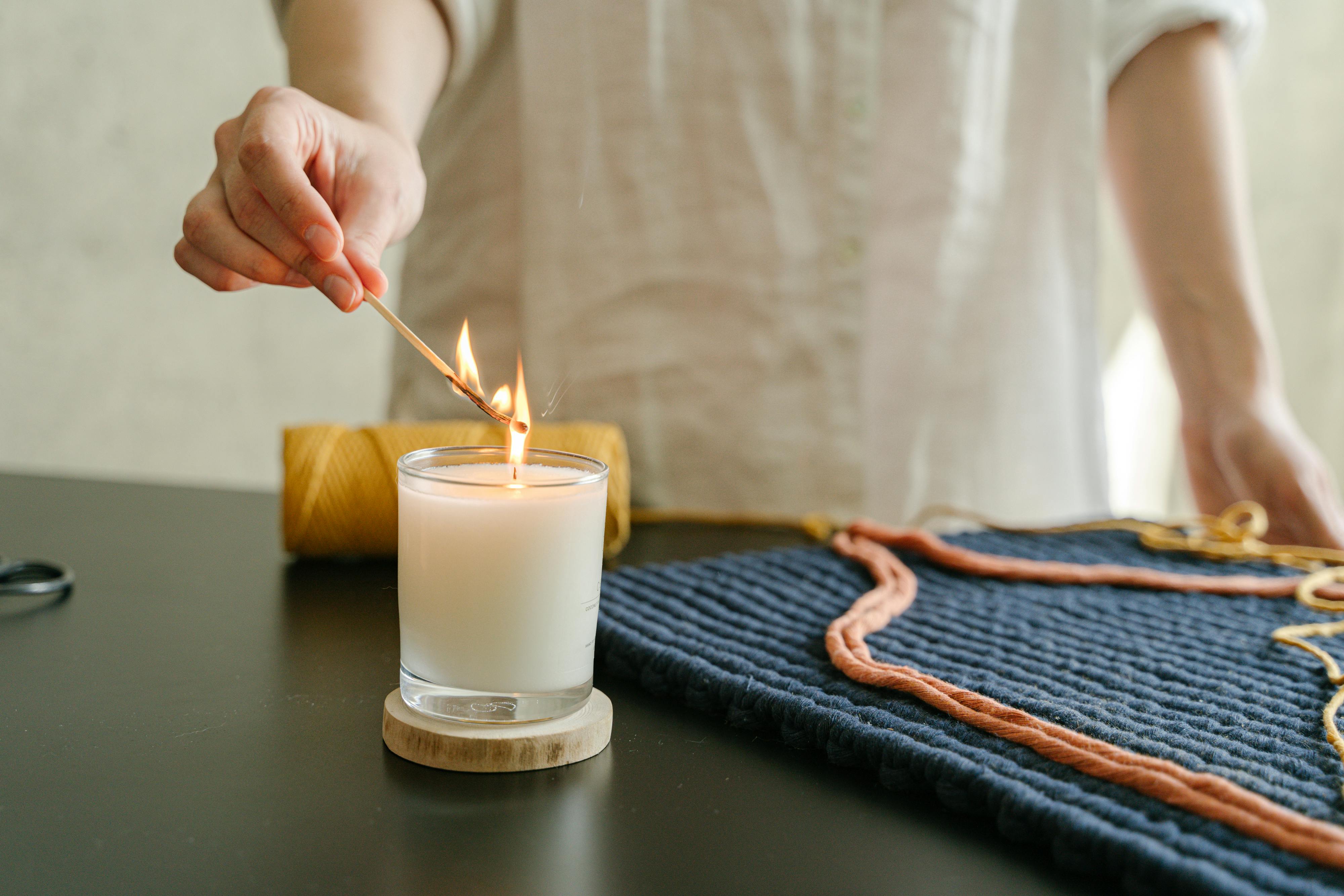 Hand Lighting a Candle on a Black Table Using a Matchstick · Free Stock ...