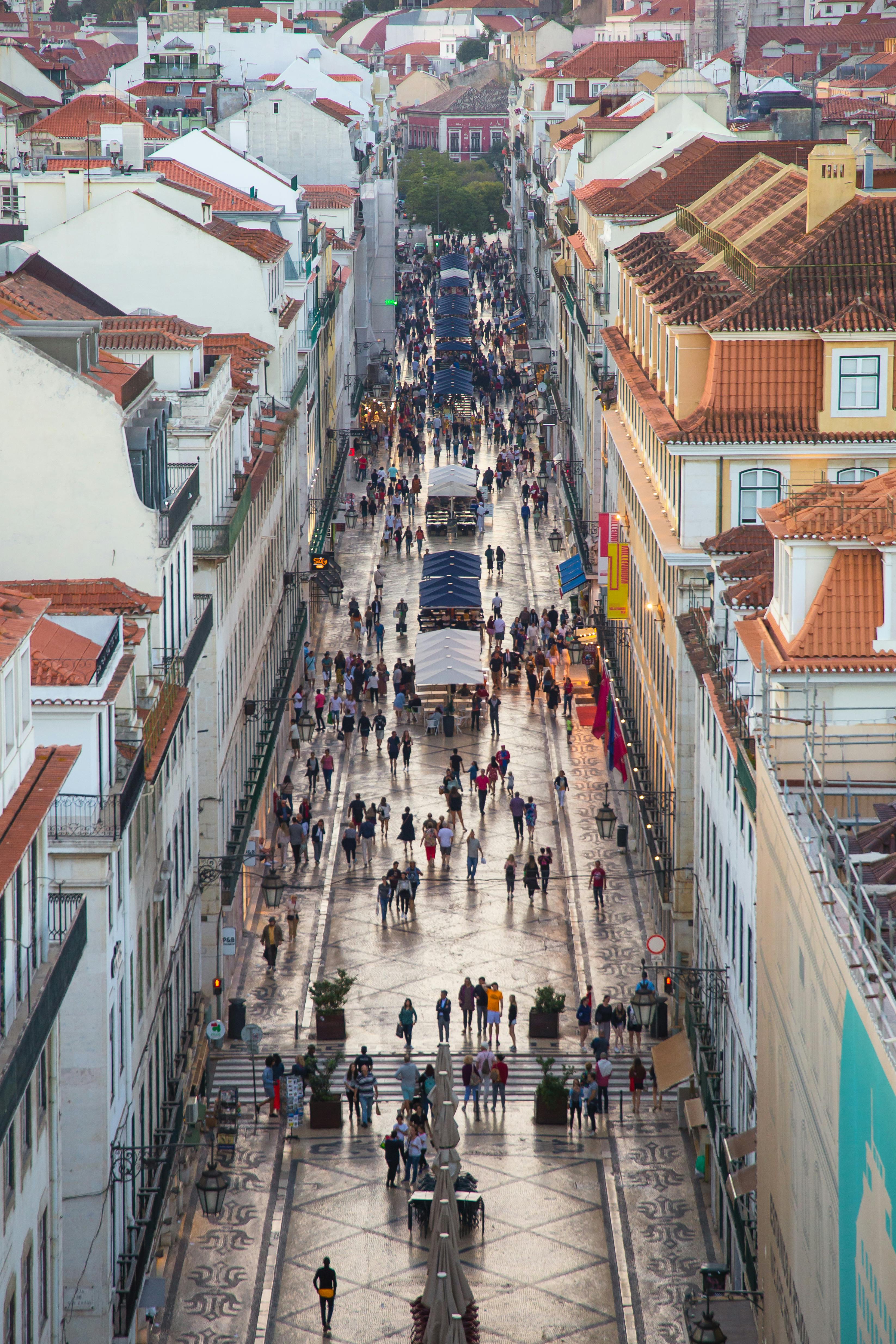 Busy narrow paved street with people · Free Stock Photo