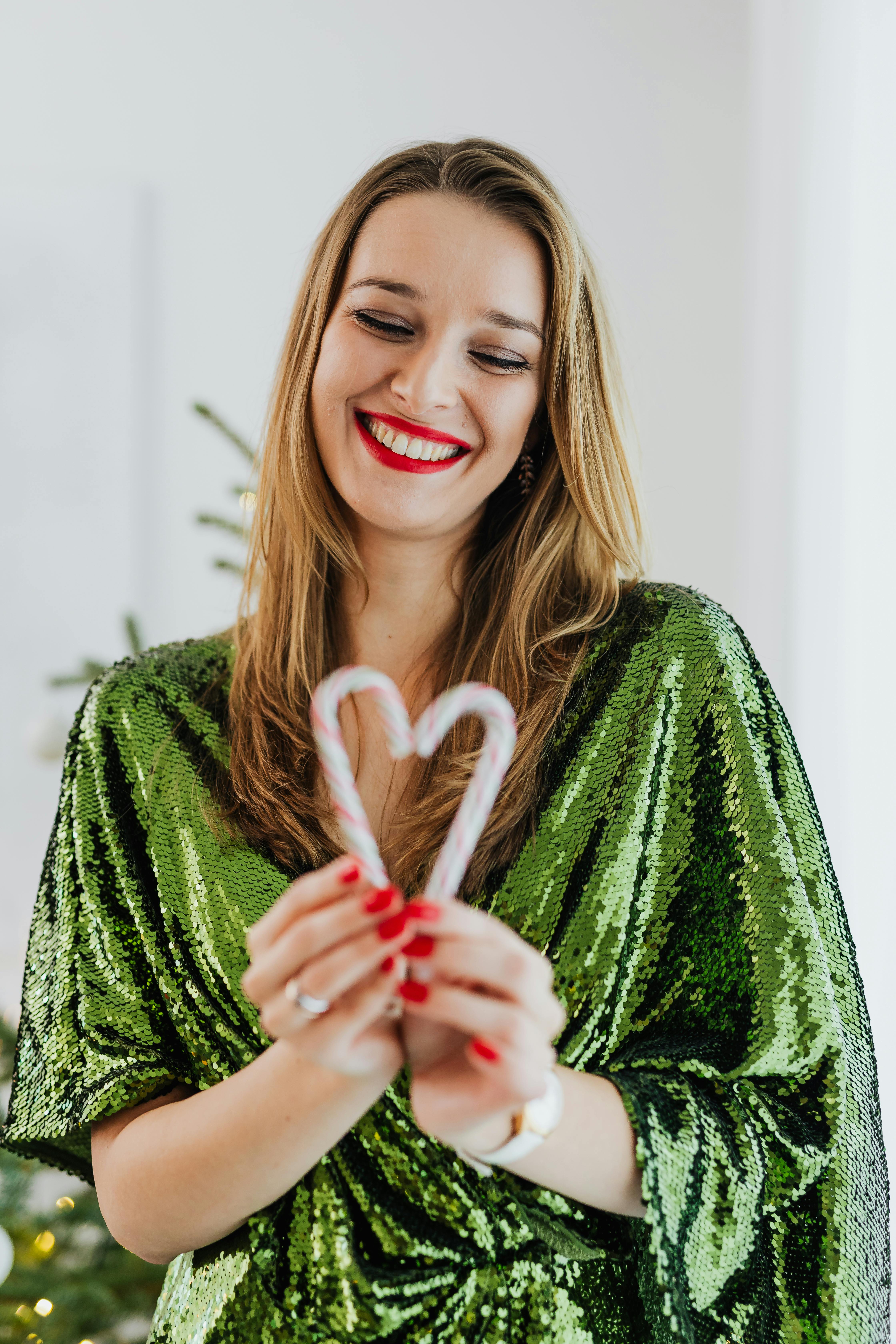 A Person Holding a Candy Cane · Free Stock Photo