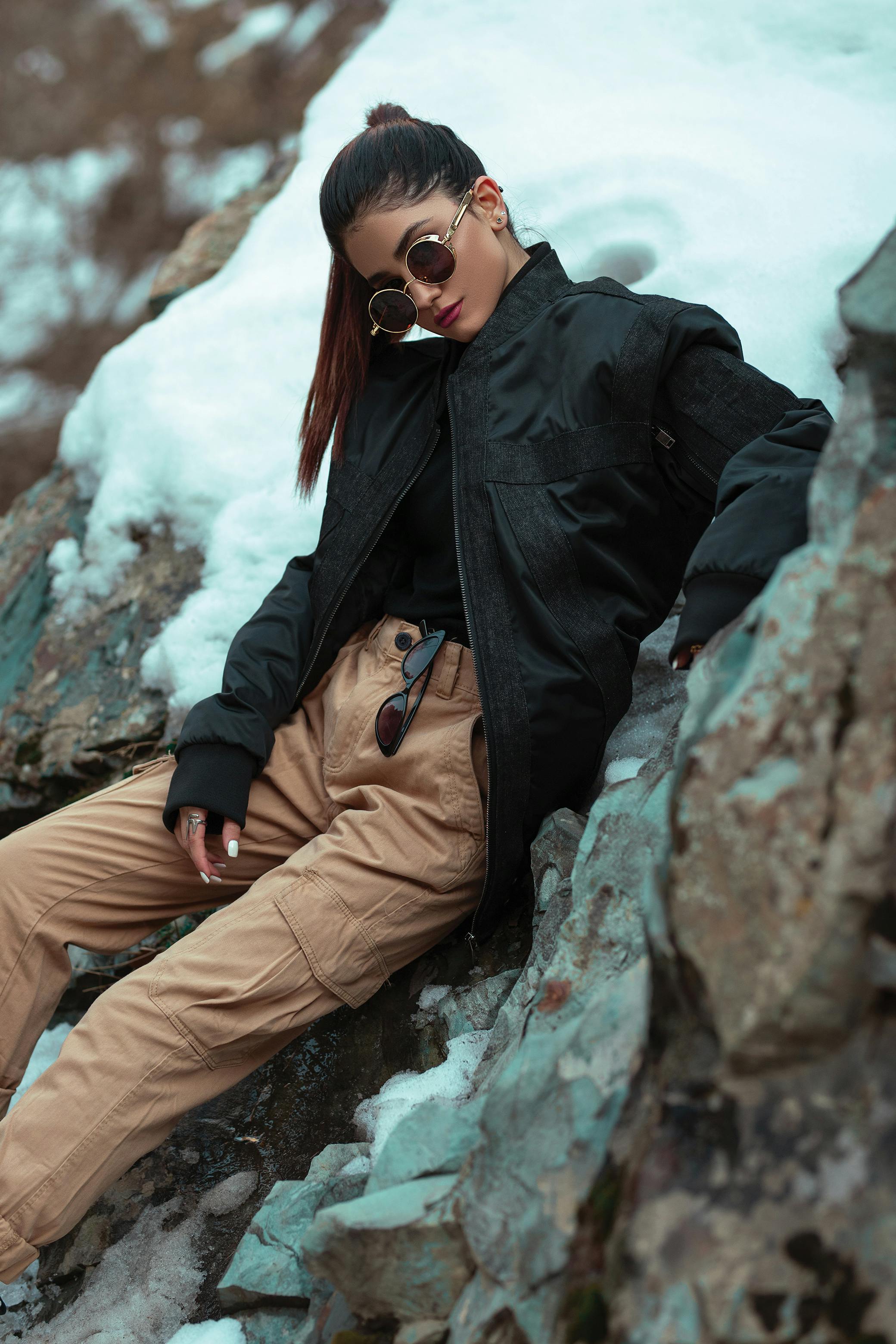 Model Posing in Warm Jacket and Pants in Mountains · Free Stock Photo