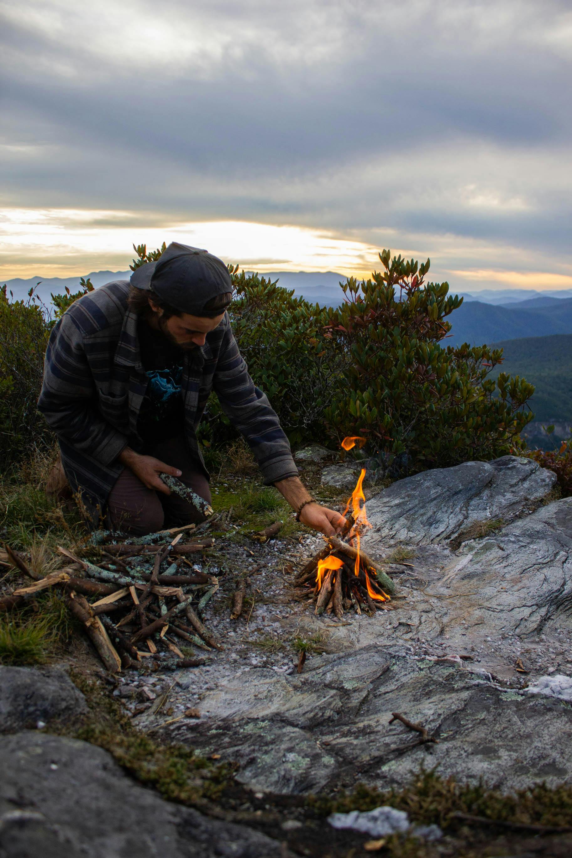 Man Lighting Campfire · Free Stock Photo