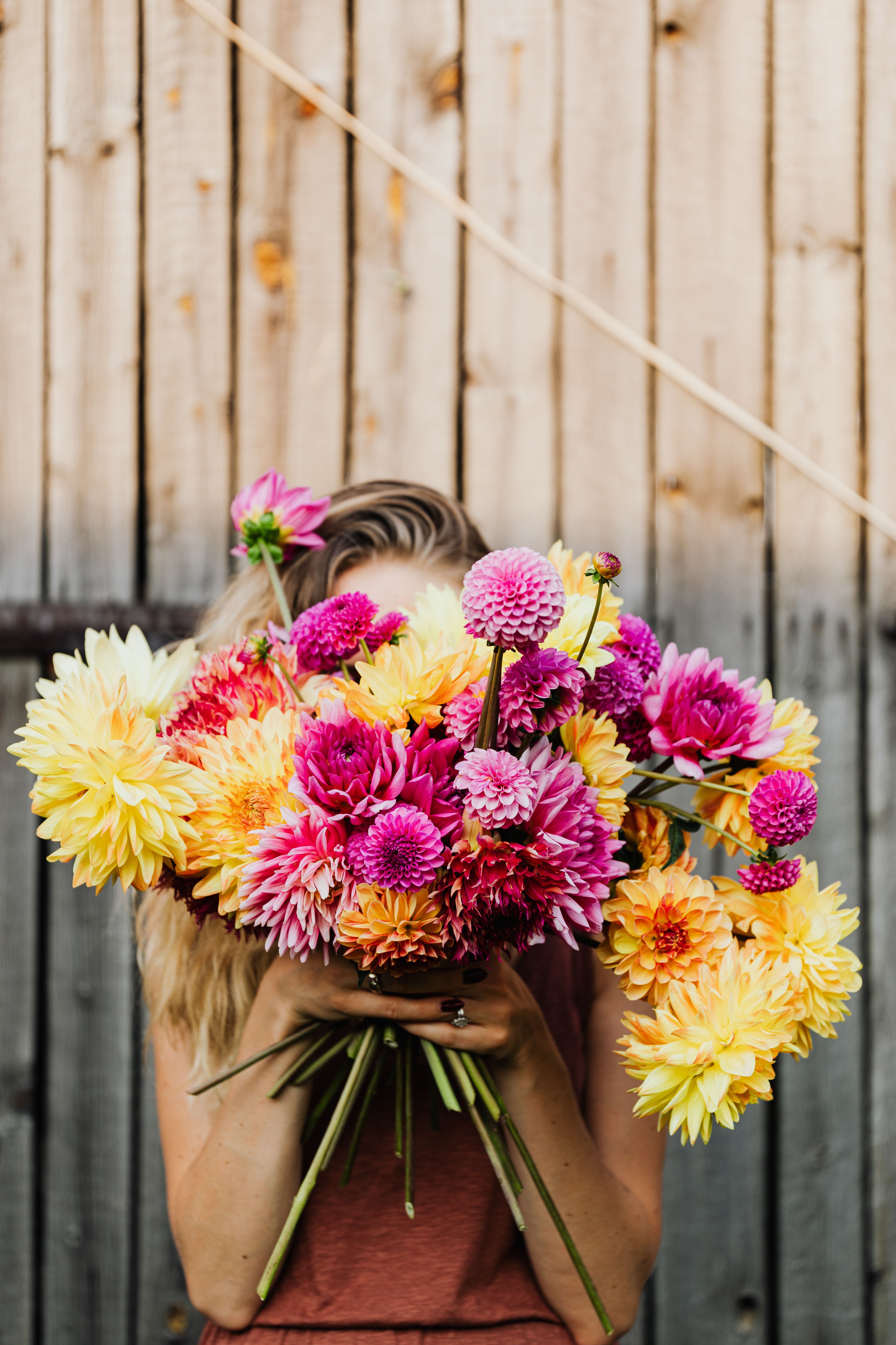 Woman Hiding Behind Flower Bouquet · Free Stock Photo