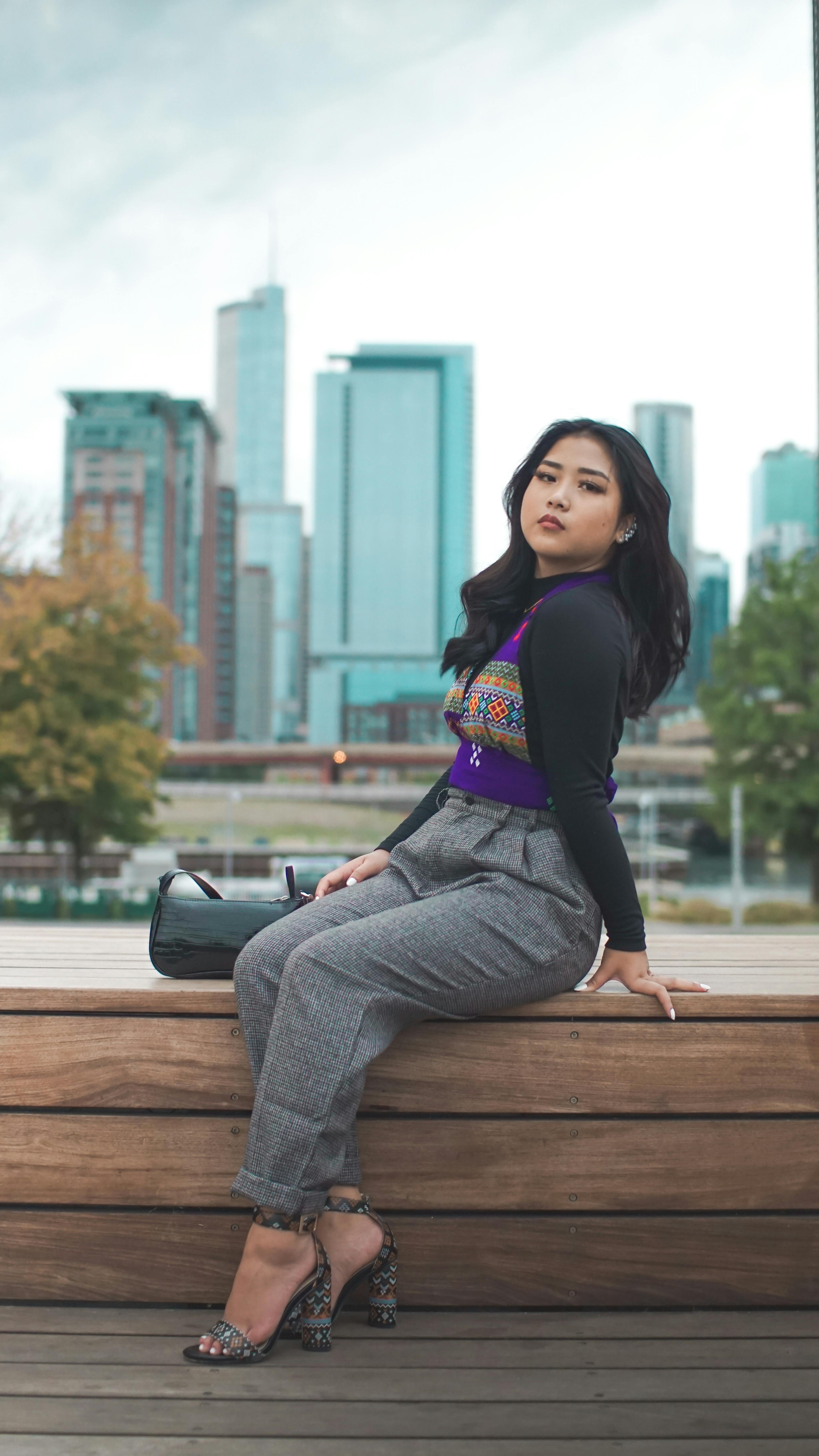 Woman Sitting and Posing by Railing · Free Stock Photo