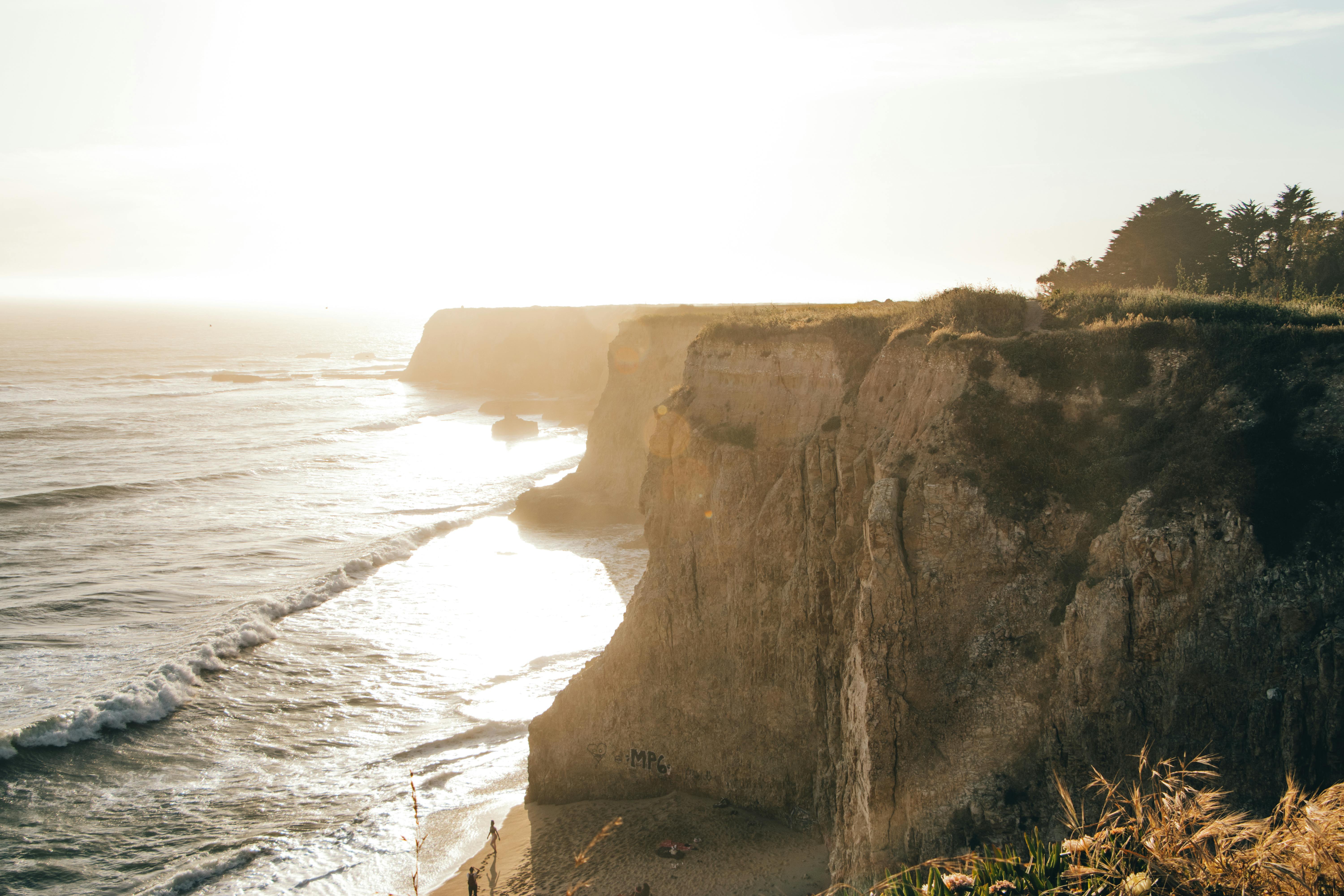 Rocky cliff near stormy ocean · Free Stock Photo