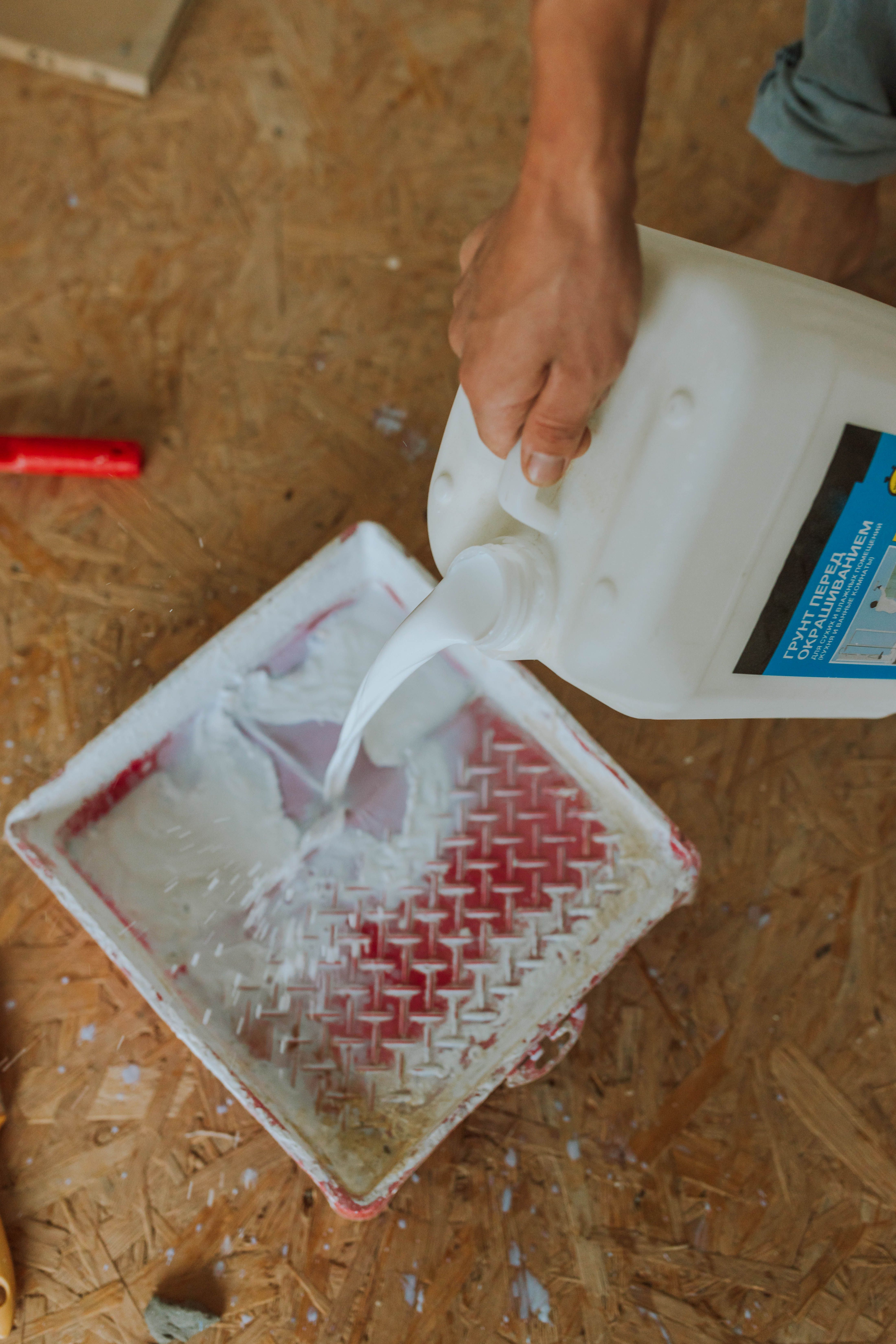 Man Pouring Paint from Bottle to Tray · Free Stock Photo
