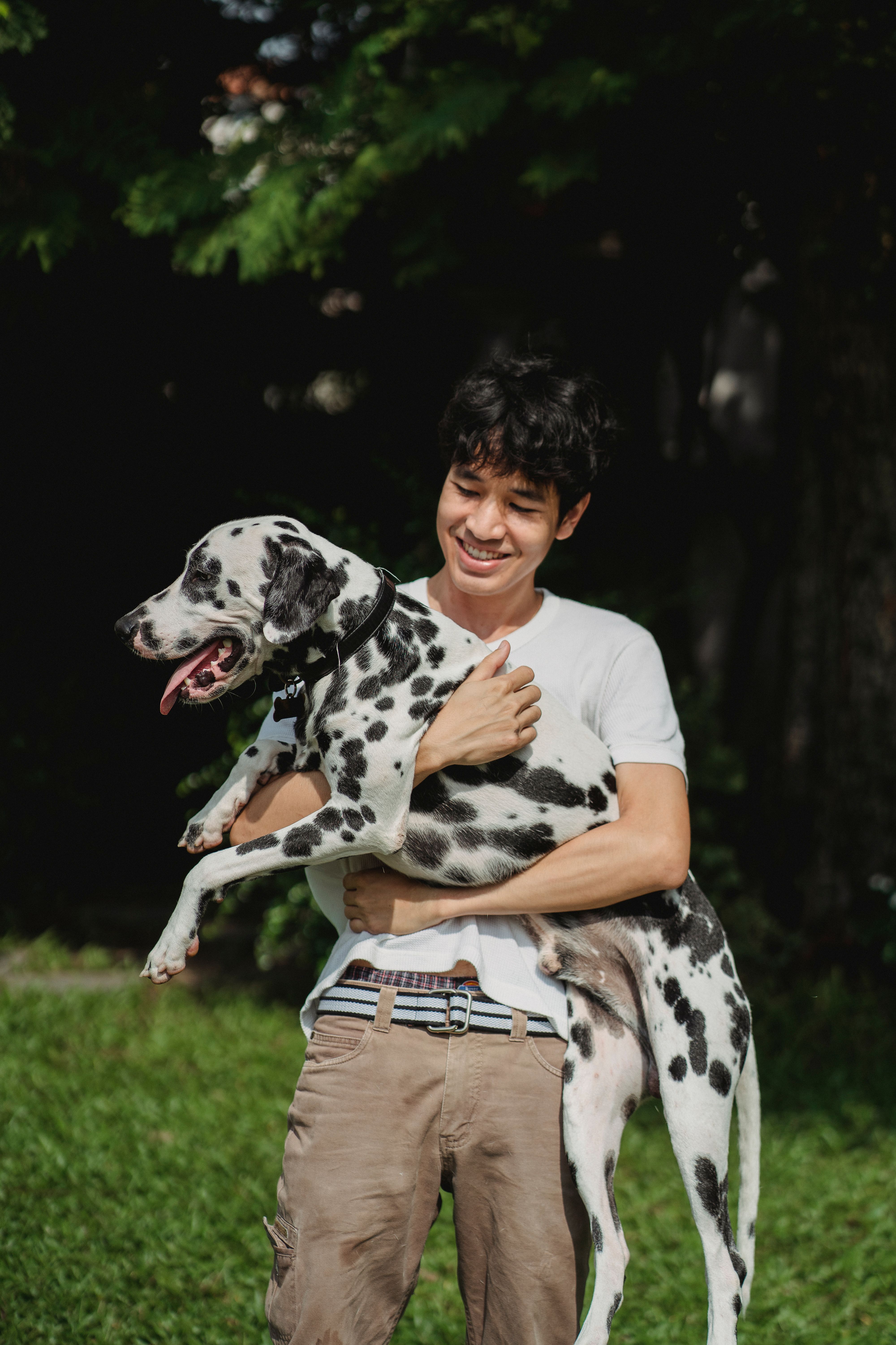 Smiling Man Holding Dalmatian · Free Stock Photo