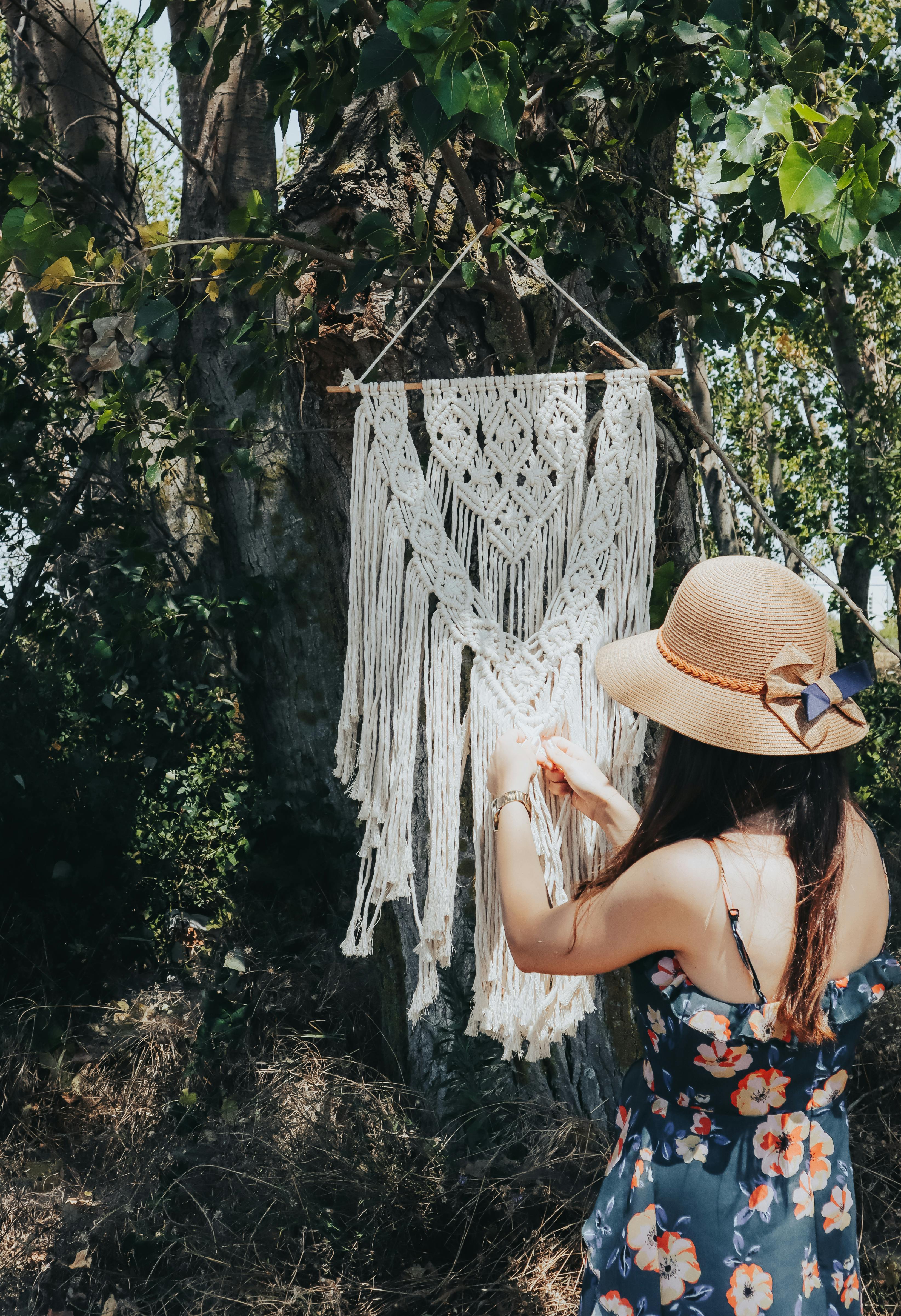 A Woman Weaving Strings by Hand · Free Stock Photo