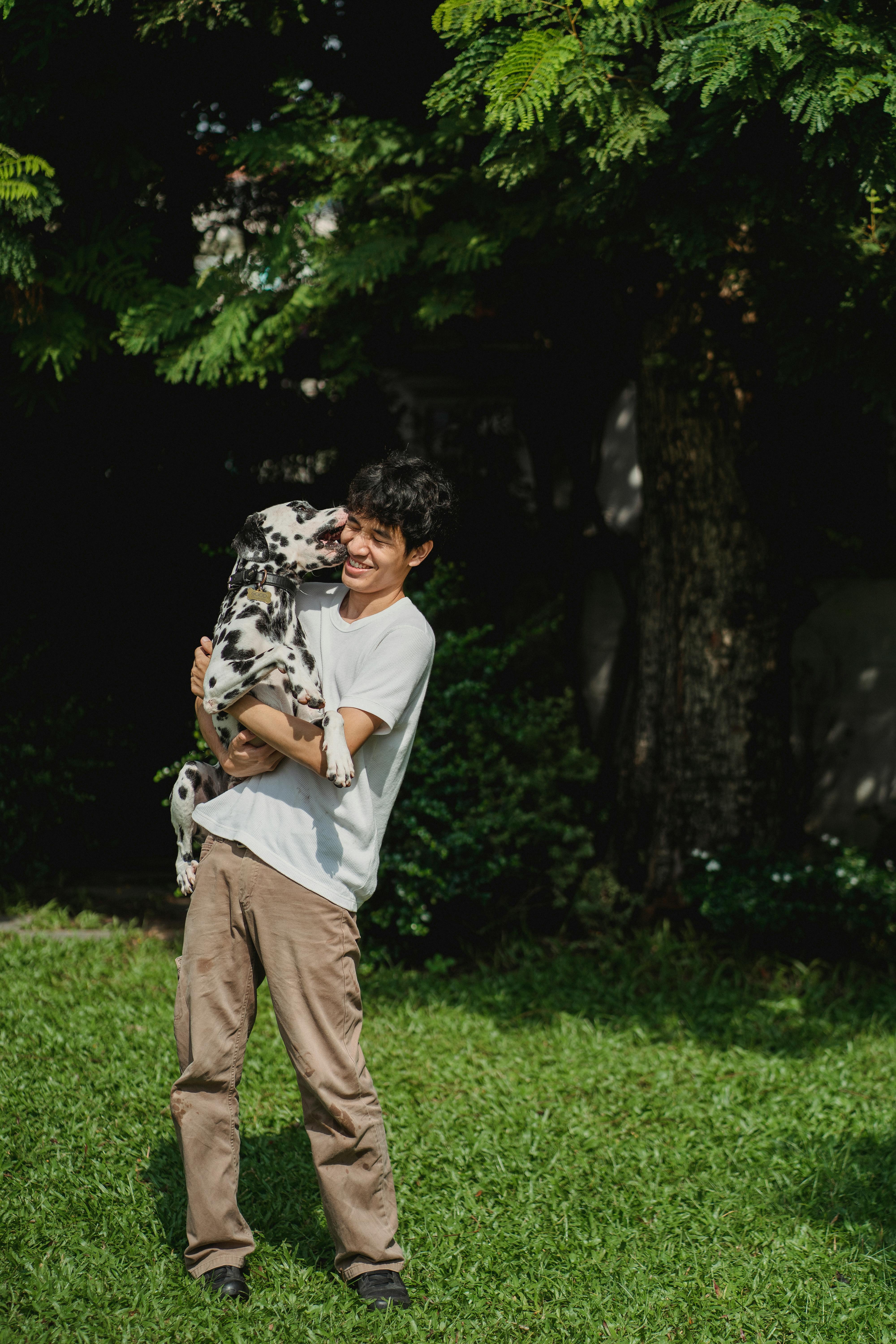 A Man Carrying HIs Pet Dog · Free Stock Photo