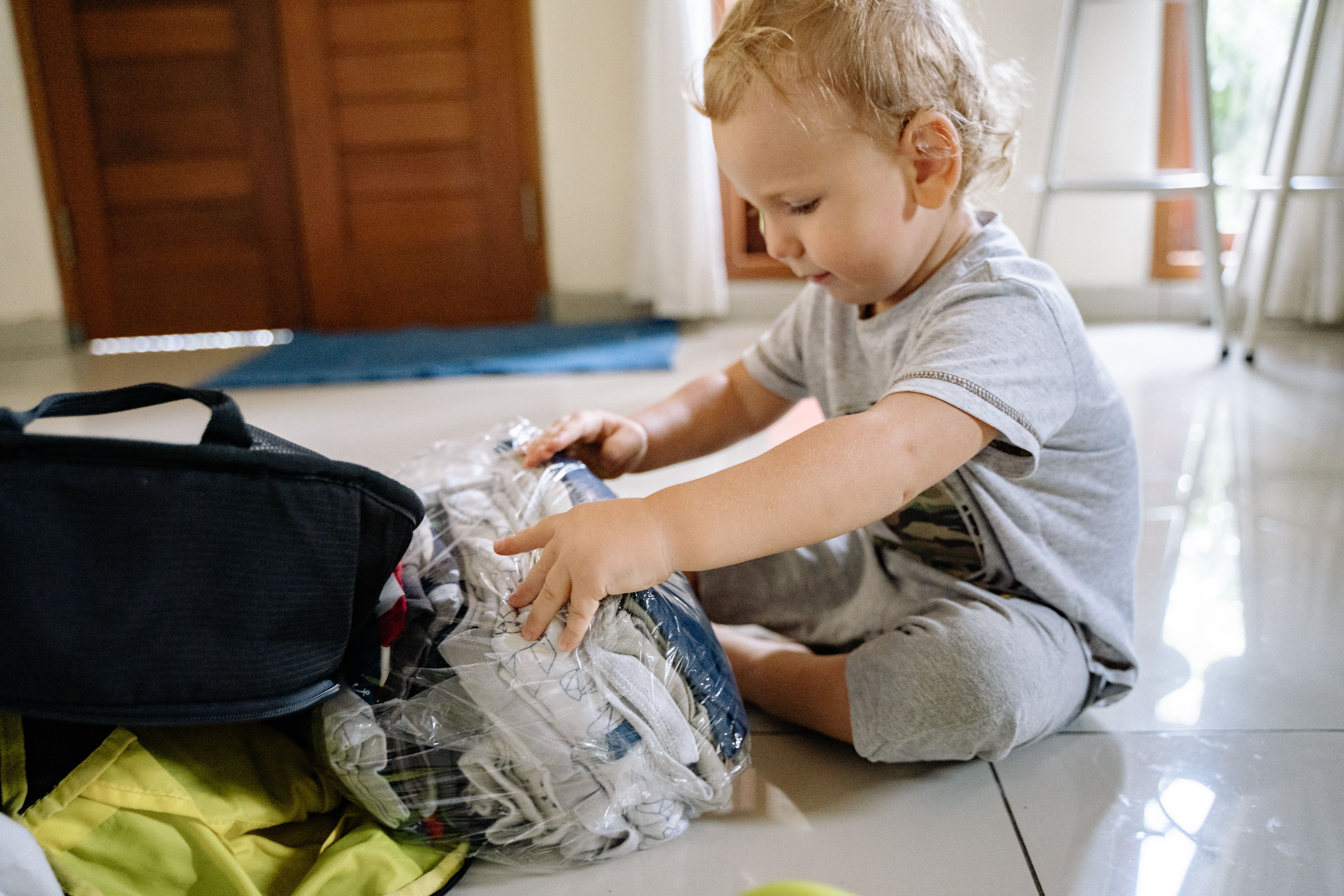 Boy in Gray Crew Neck T-shirt and Gray Pants Sitting on White Floor ...