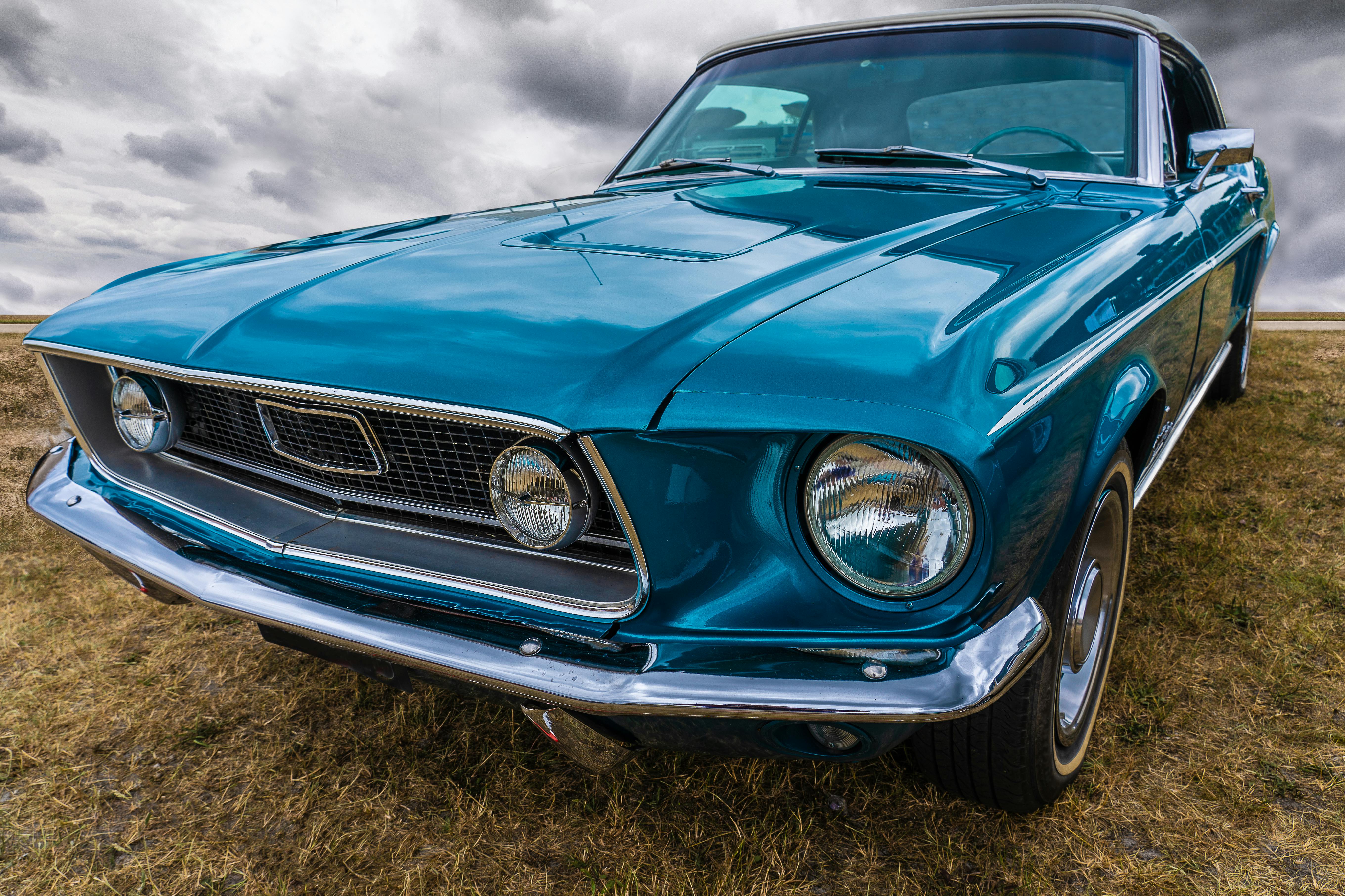Blue Car on Brown Grass Field Under White Clouds · Free Stock Photo