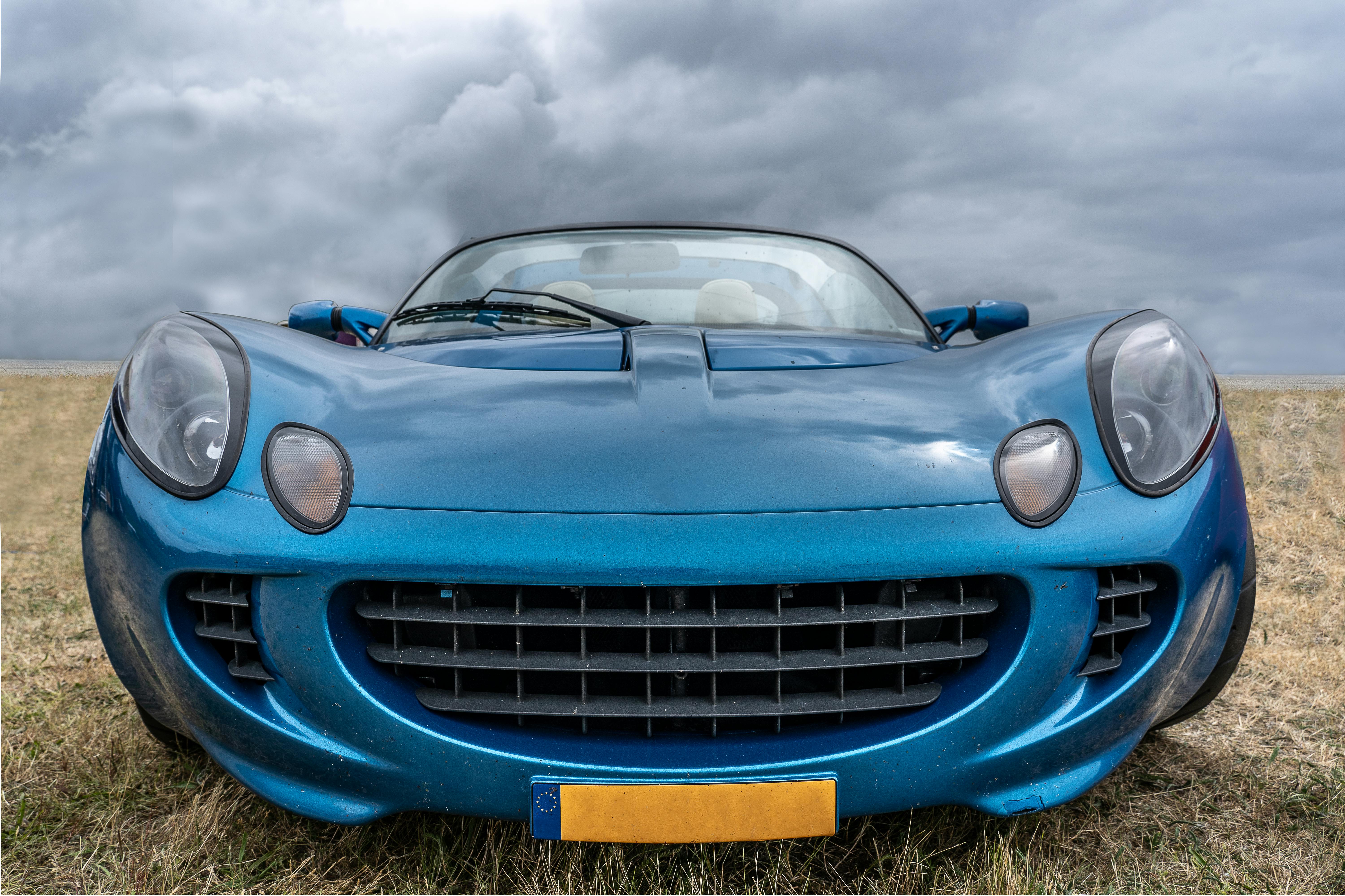 Blue Car Under Cloudy Sky · Free Stock Photo