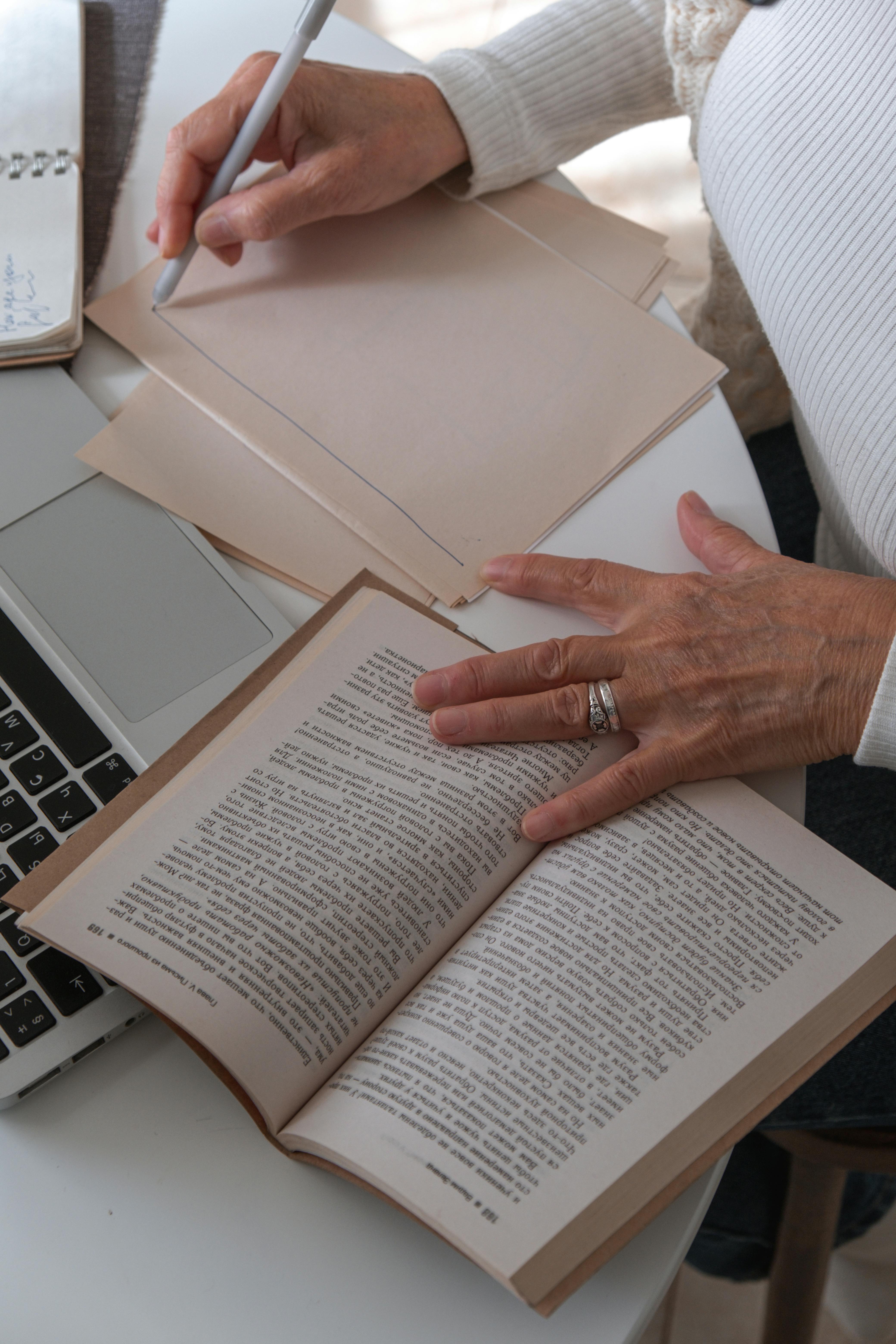 Top View Photo Of Man Reading A Book · Free Stock Photo
