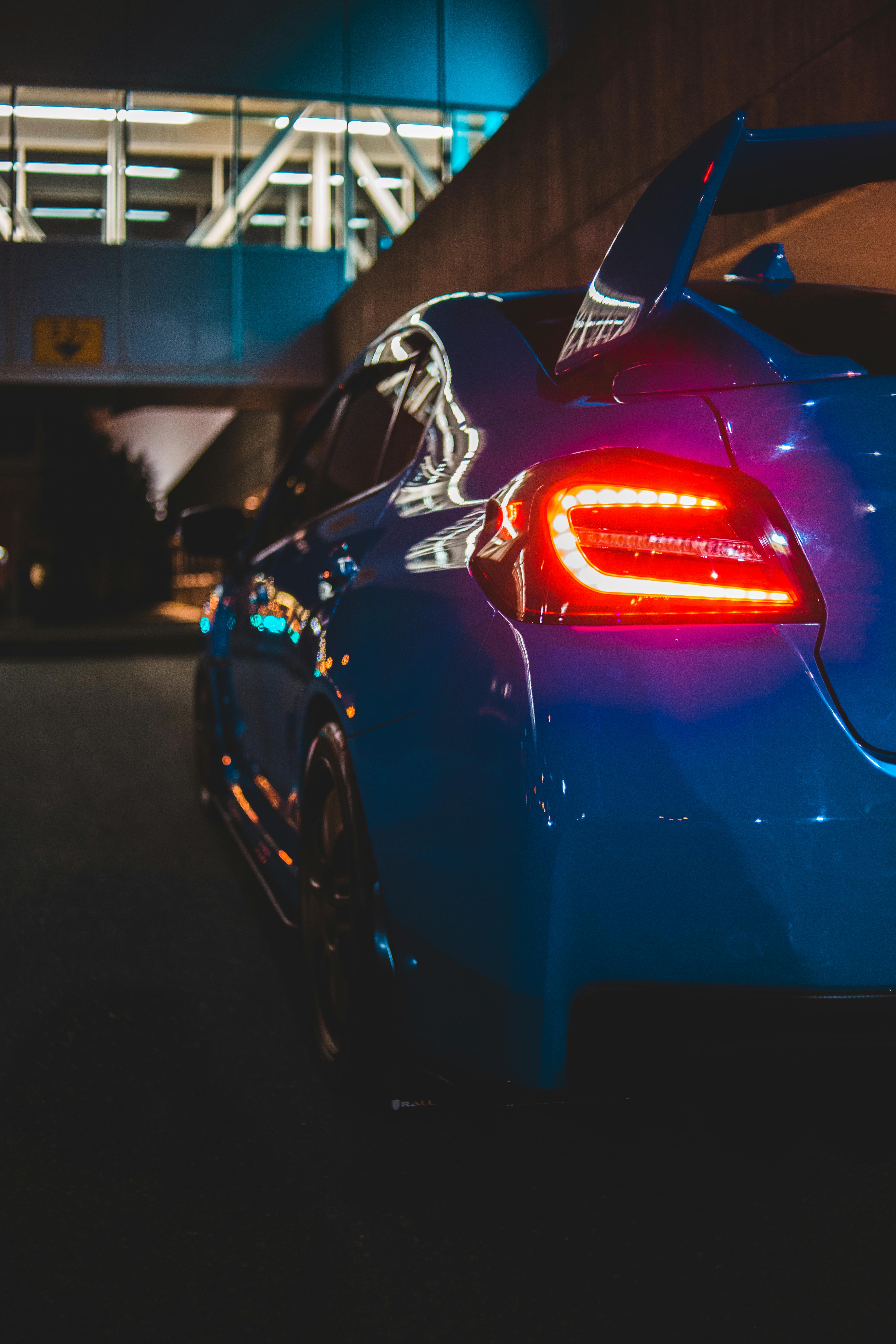 Modern shiny sports car on road at night · Free Stock Photo