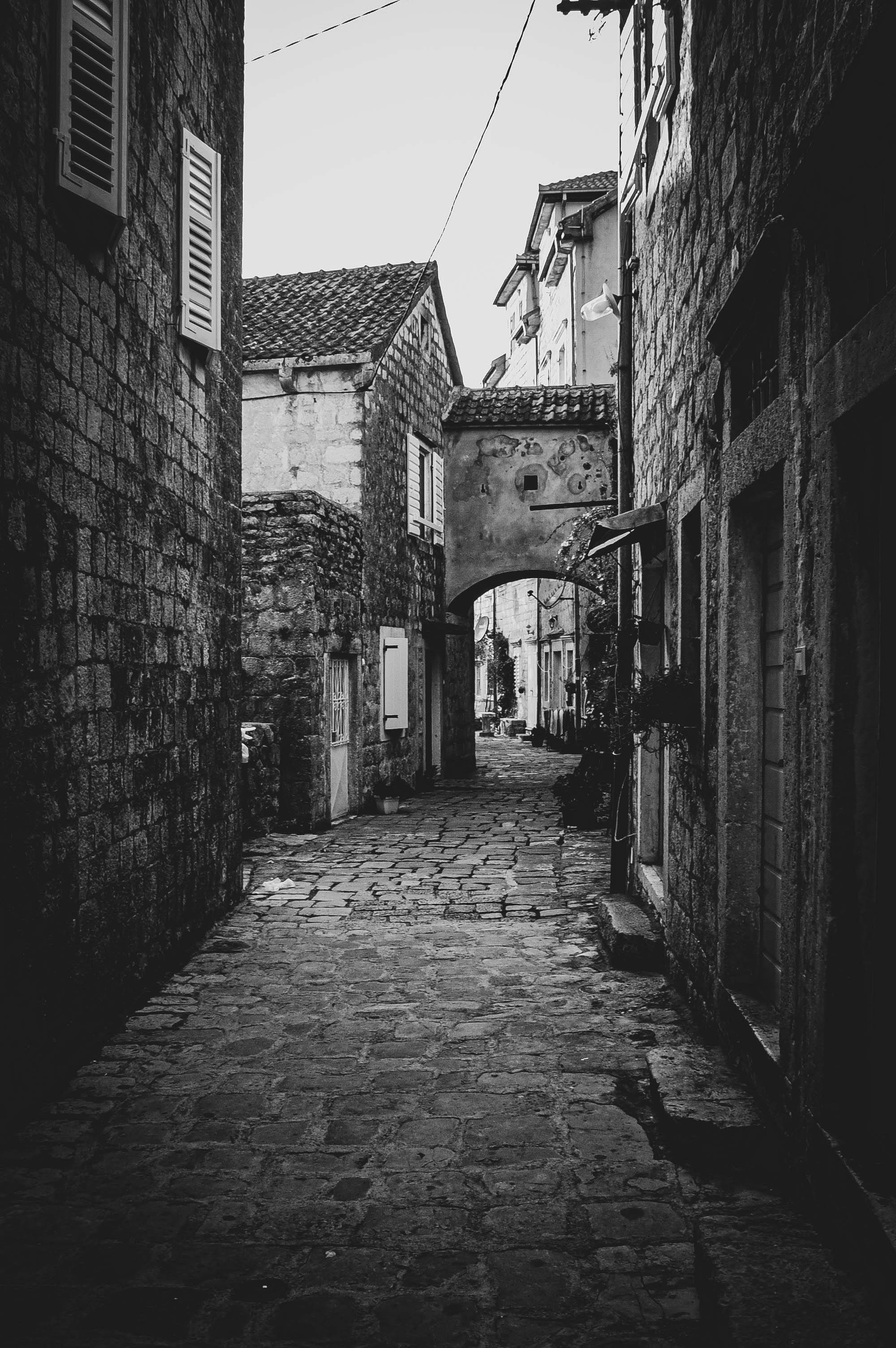 Grayscale Photo of Brick Buildings · Free Stock Photo