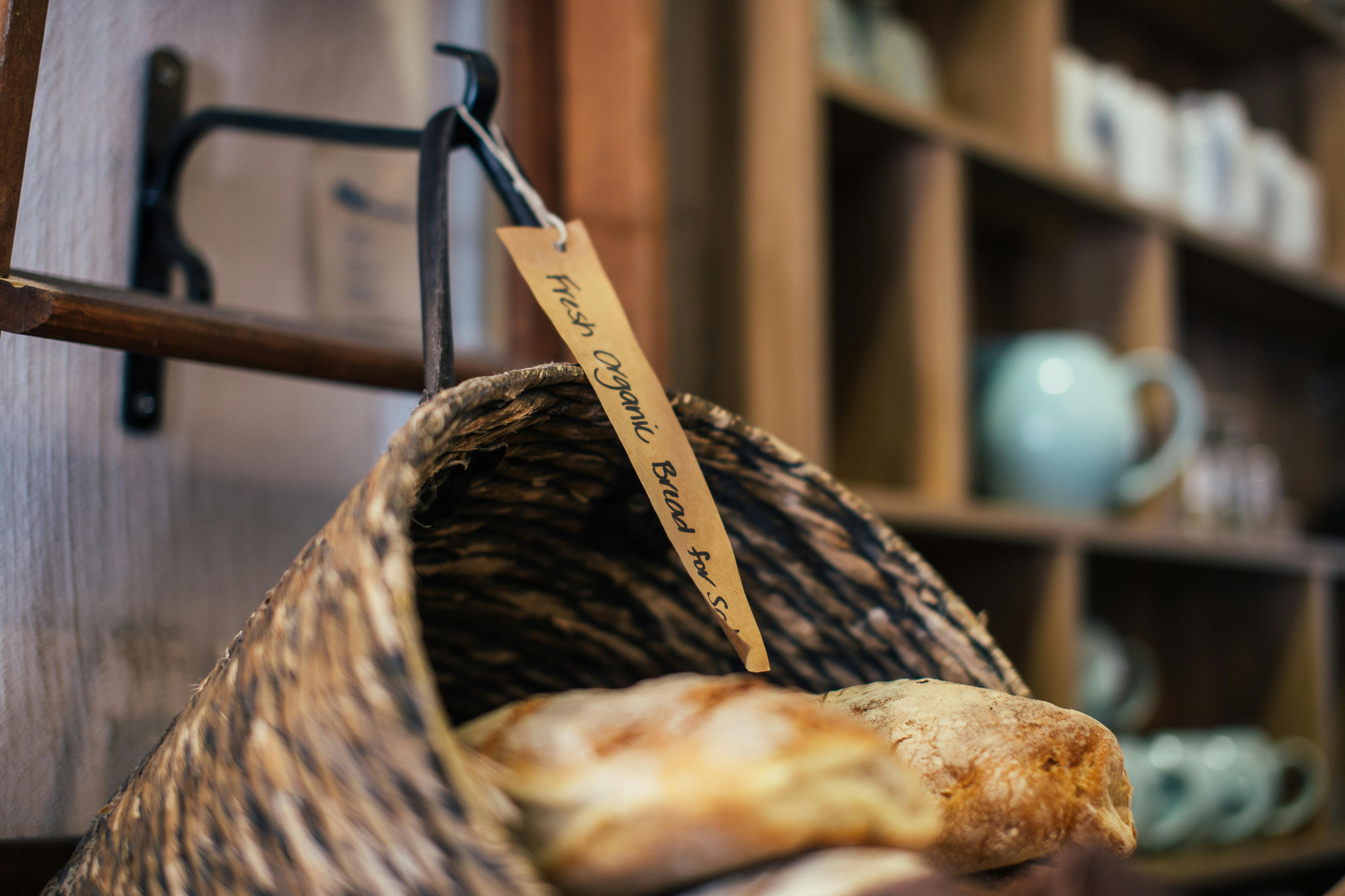Fresh baked baguettes in wicker bucket in market · Free Stock Photo