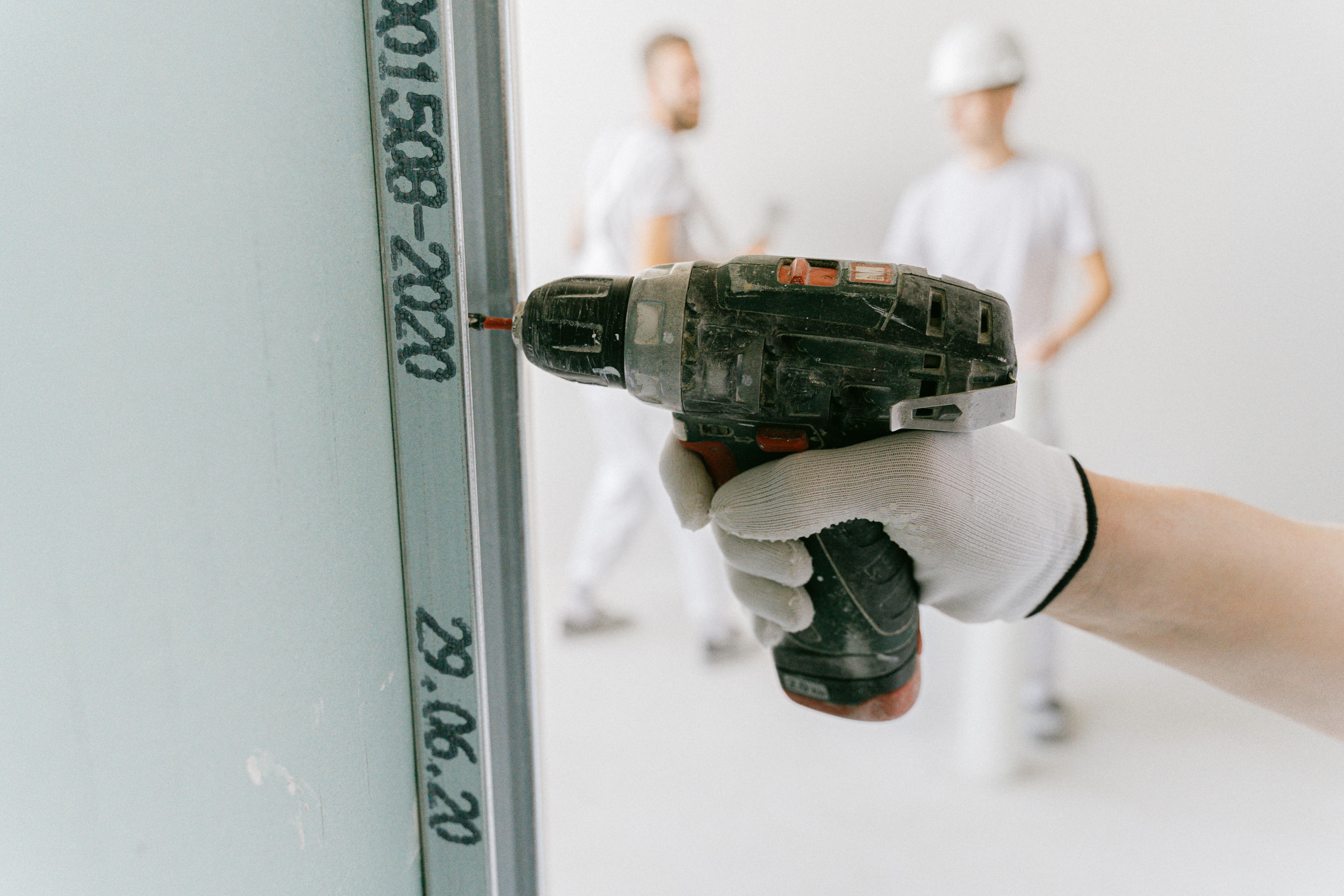 Close Up Photo of Person Drilling on White Surface · Free Stock Photo