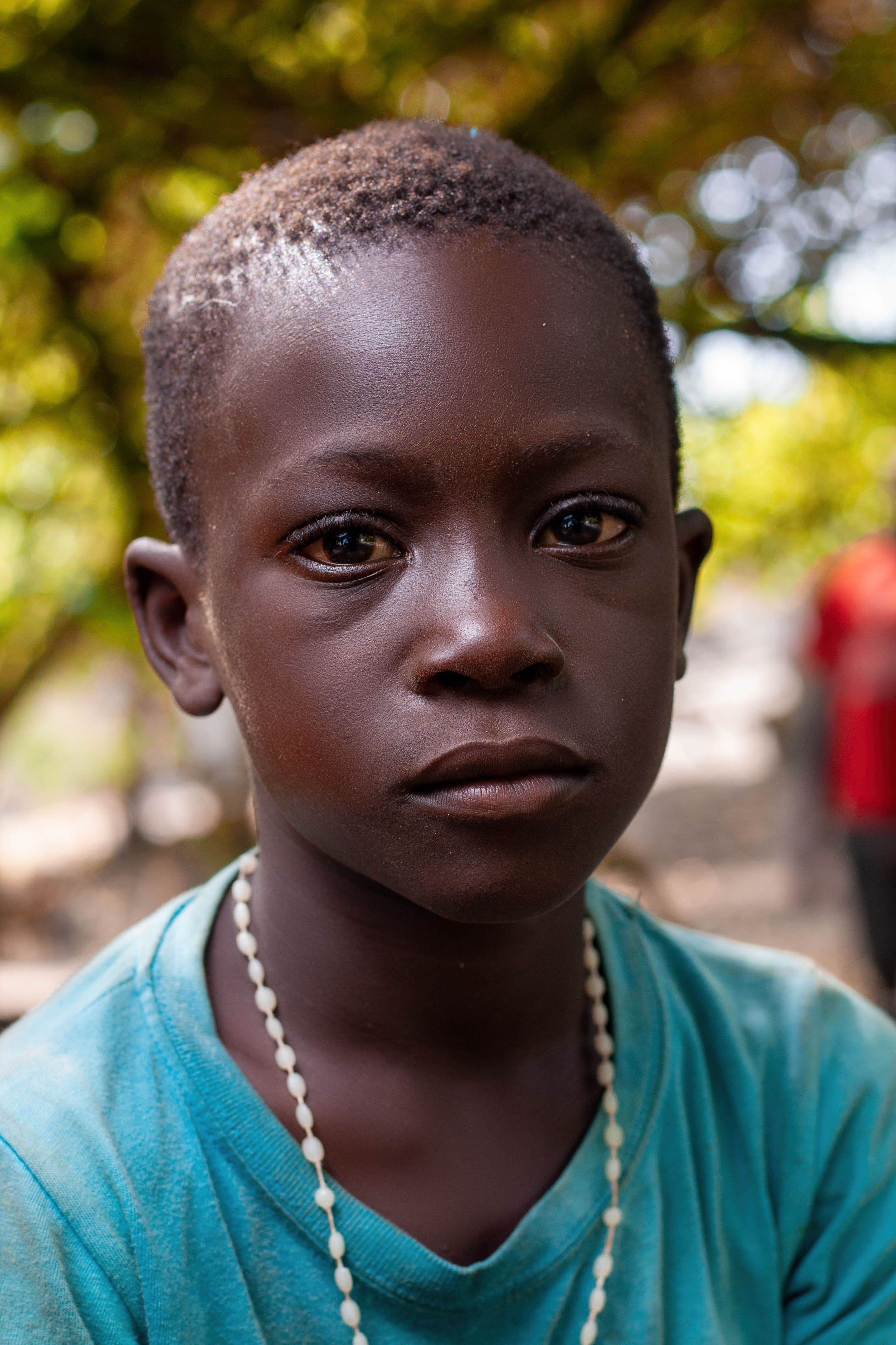 Portrait of a Boy Wearing a Rosary on His Neck · Free Stock Photo