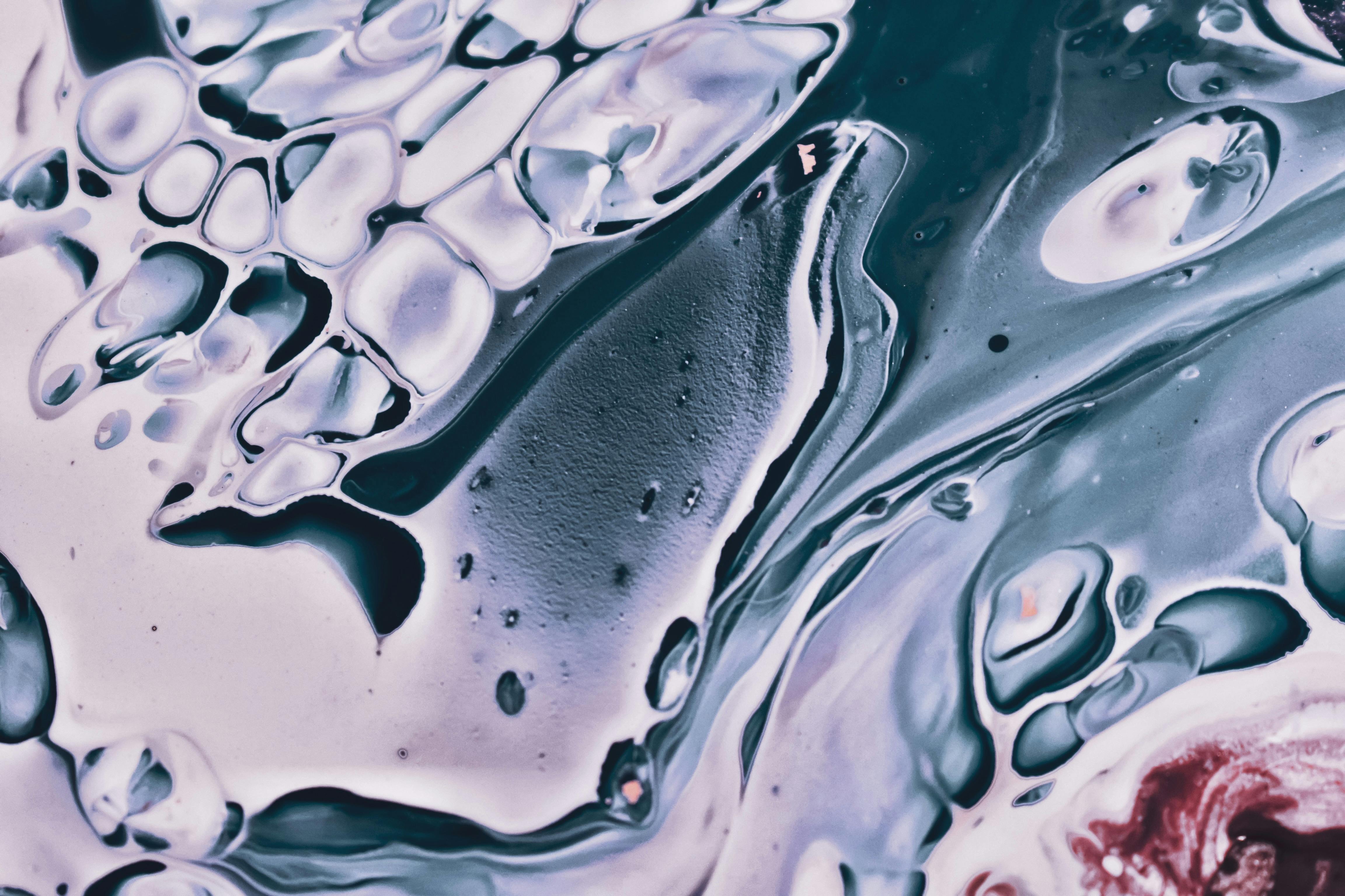 Flowing mixed liquid paints as abstract background · Free Stock Photo