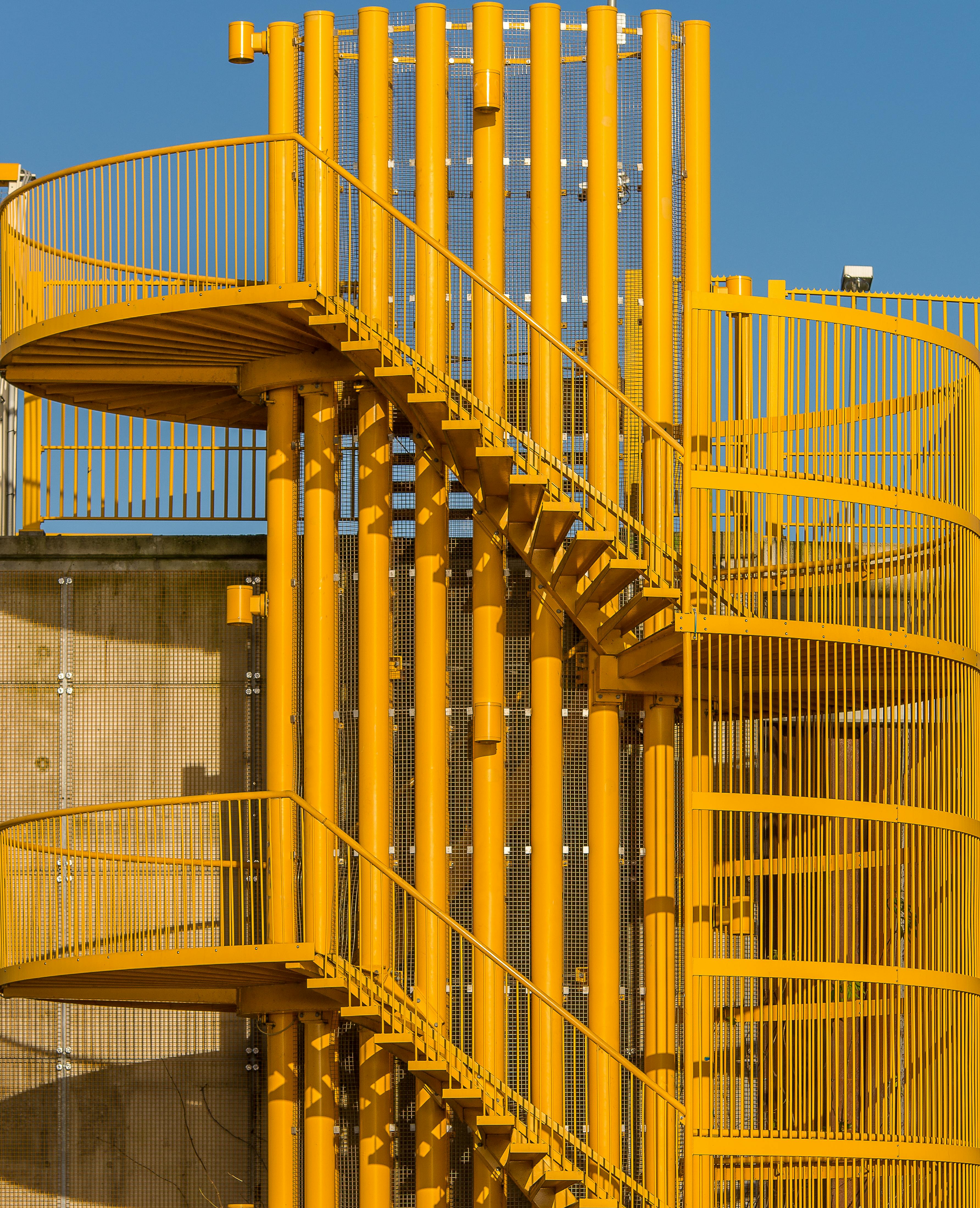 Yellow Metal Staircase Beside a Building · Free Stock Photo