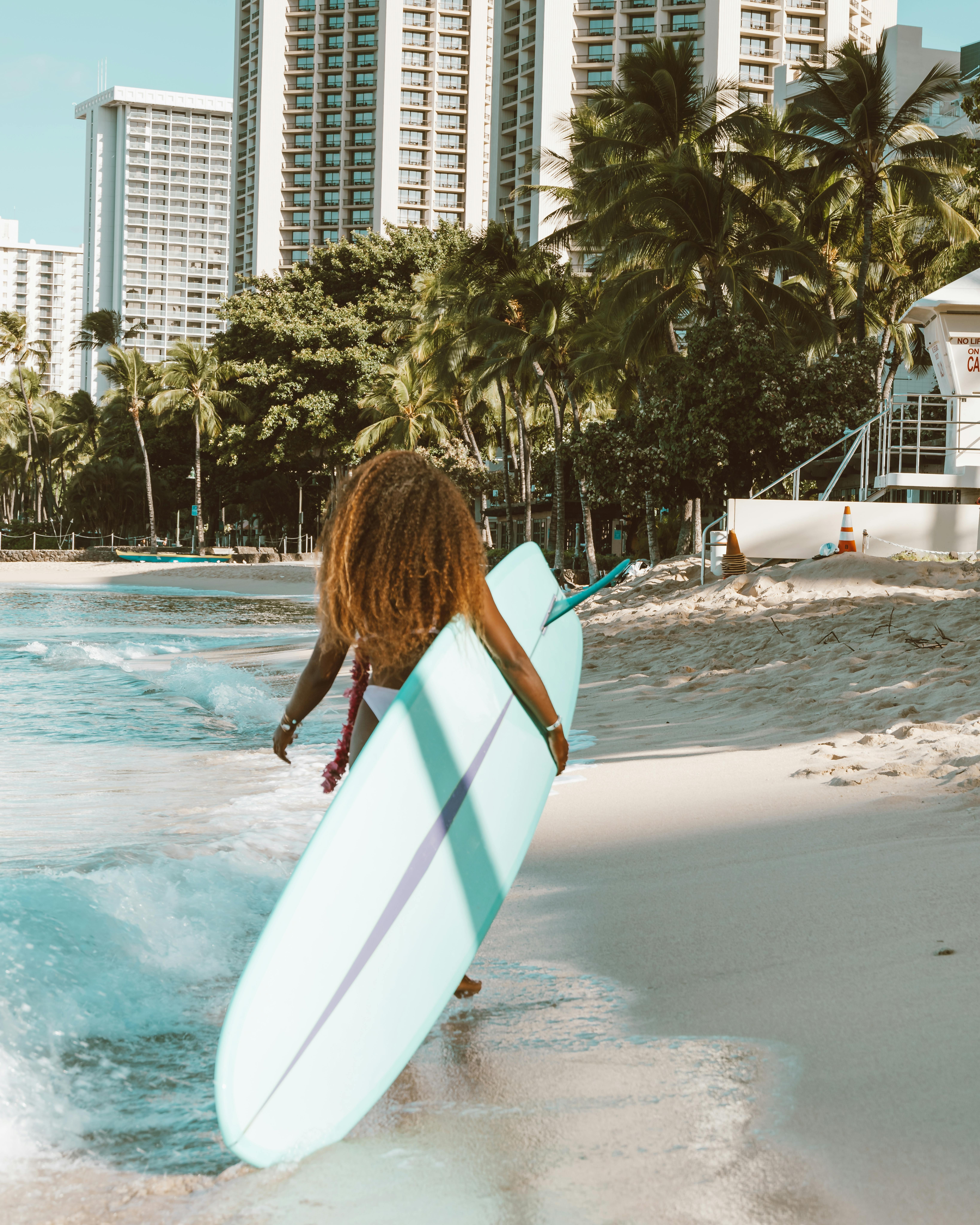 Back View of a Person Holding Surfboard on the Beach · Free Stock Photo