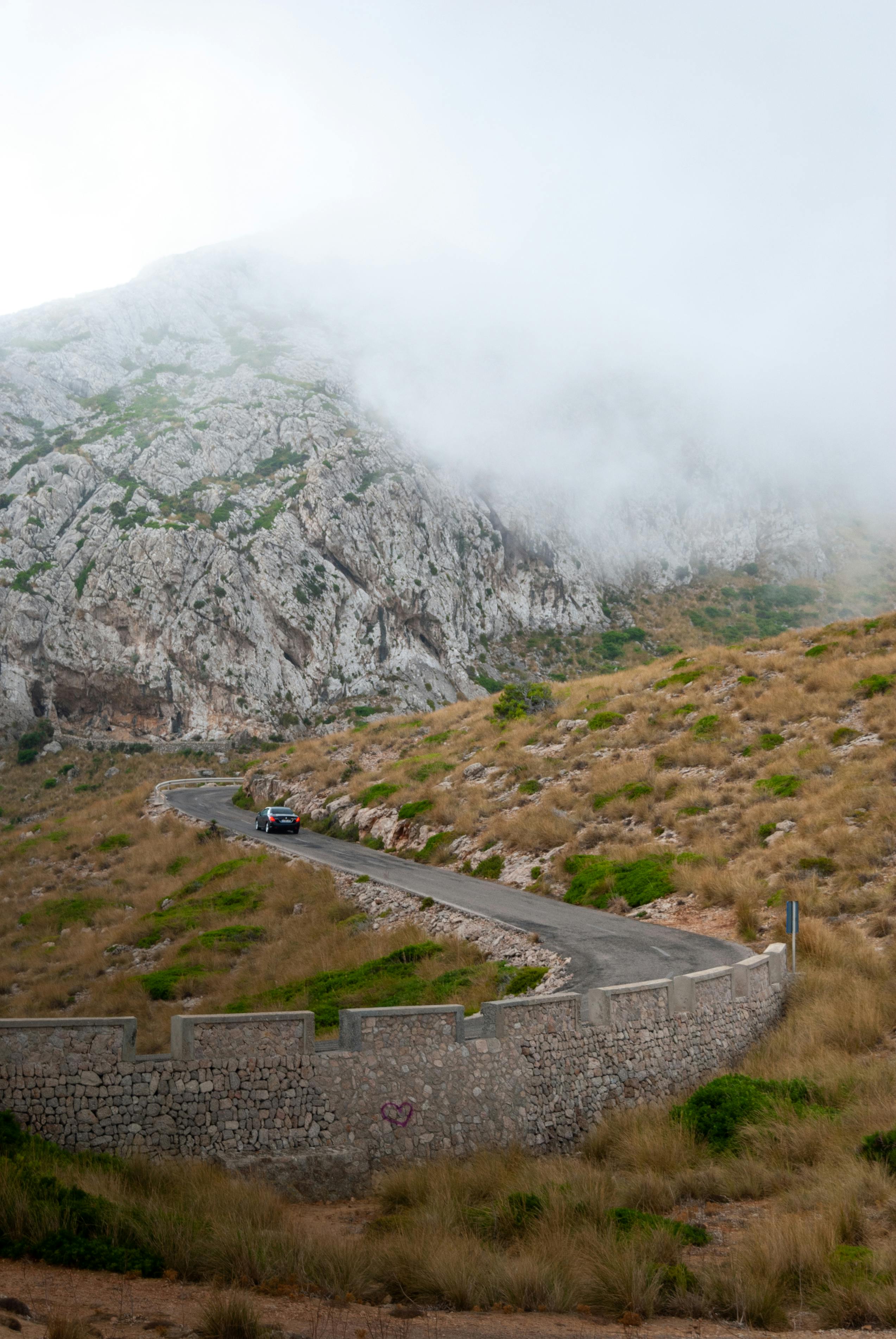 Car Driving Through Road in Mountains · Free Stock Photo