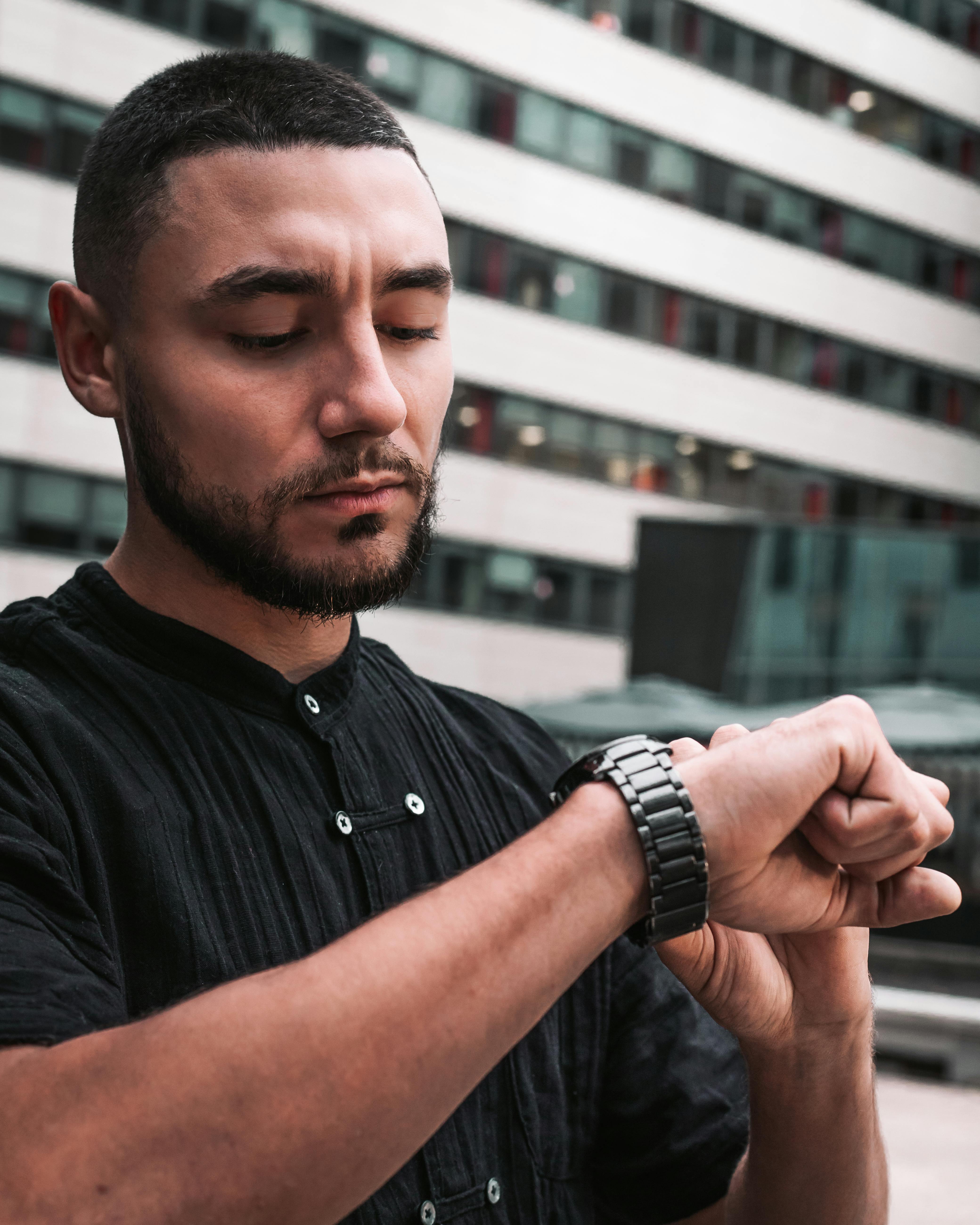 Brunette Man Looking At Wrist Watch · Free Stock Photo