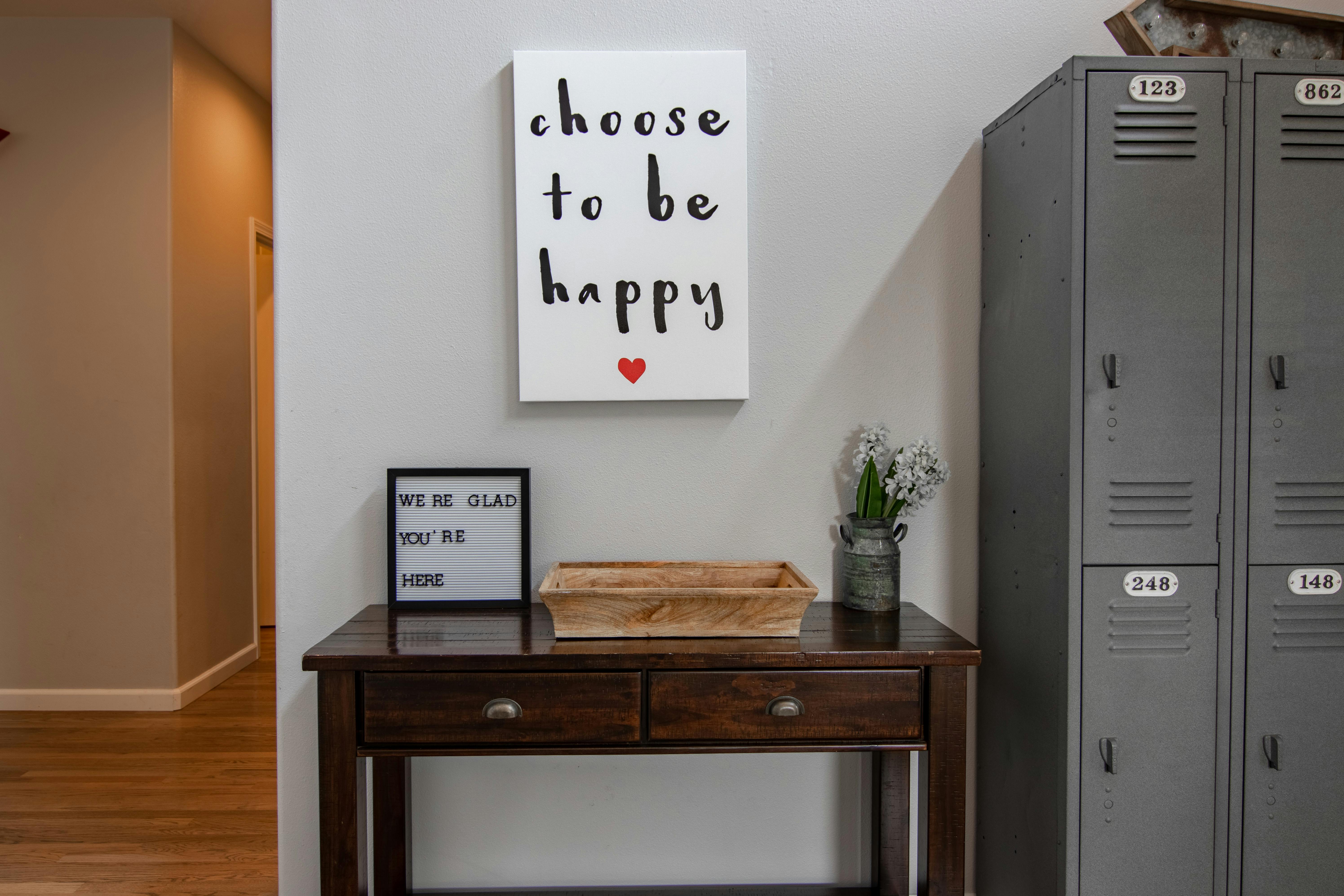 Inspirational Quotes above Wooden Desk next to Lockers · Free Stock Photo