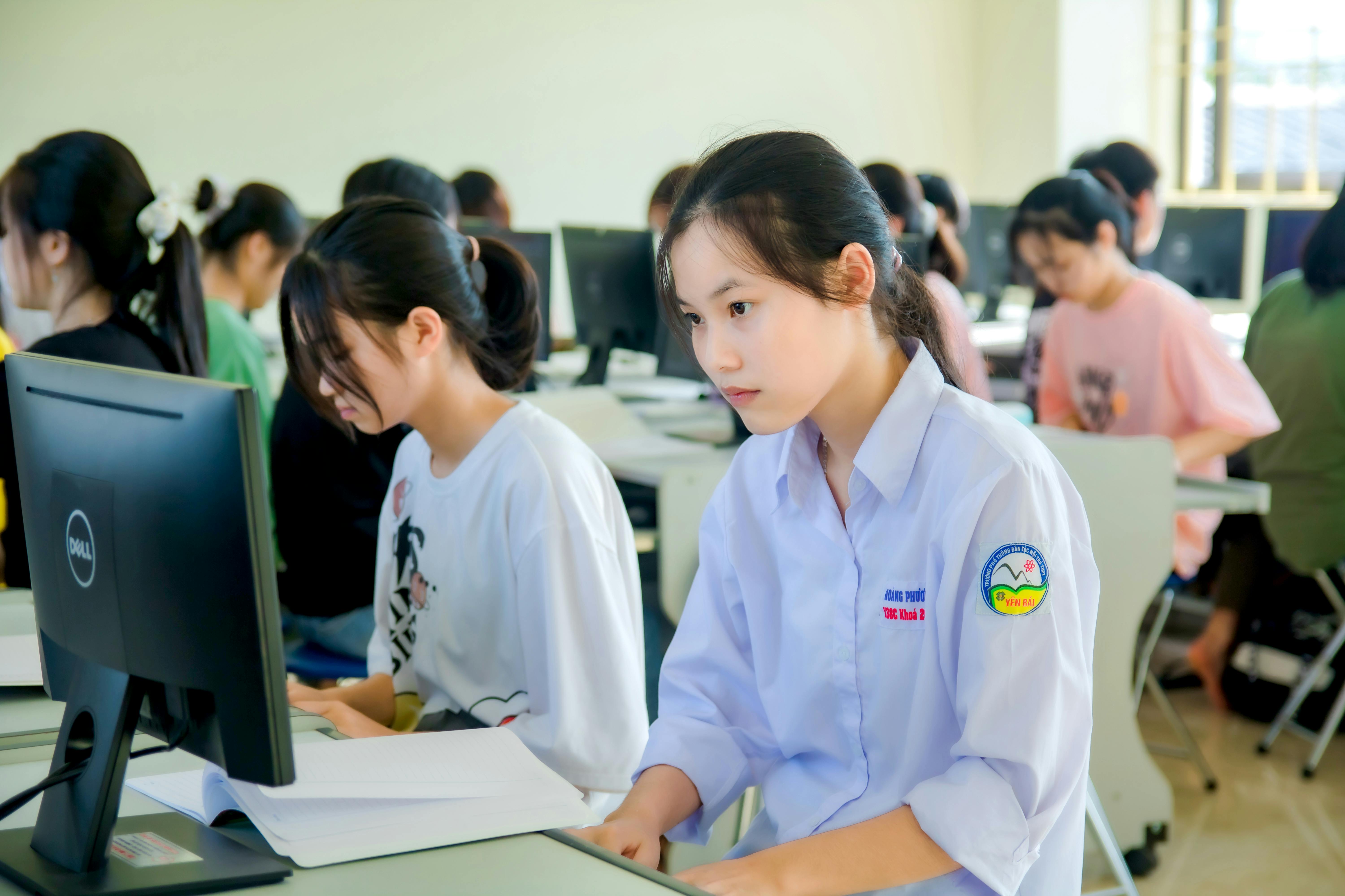 Woman in White School Uniform Sitting Beside Woman in White Shirt ...