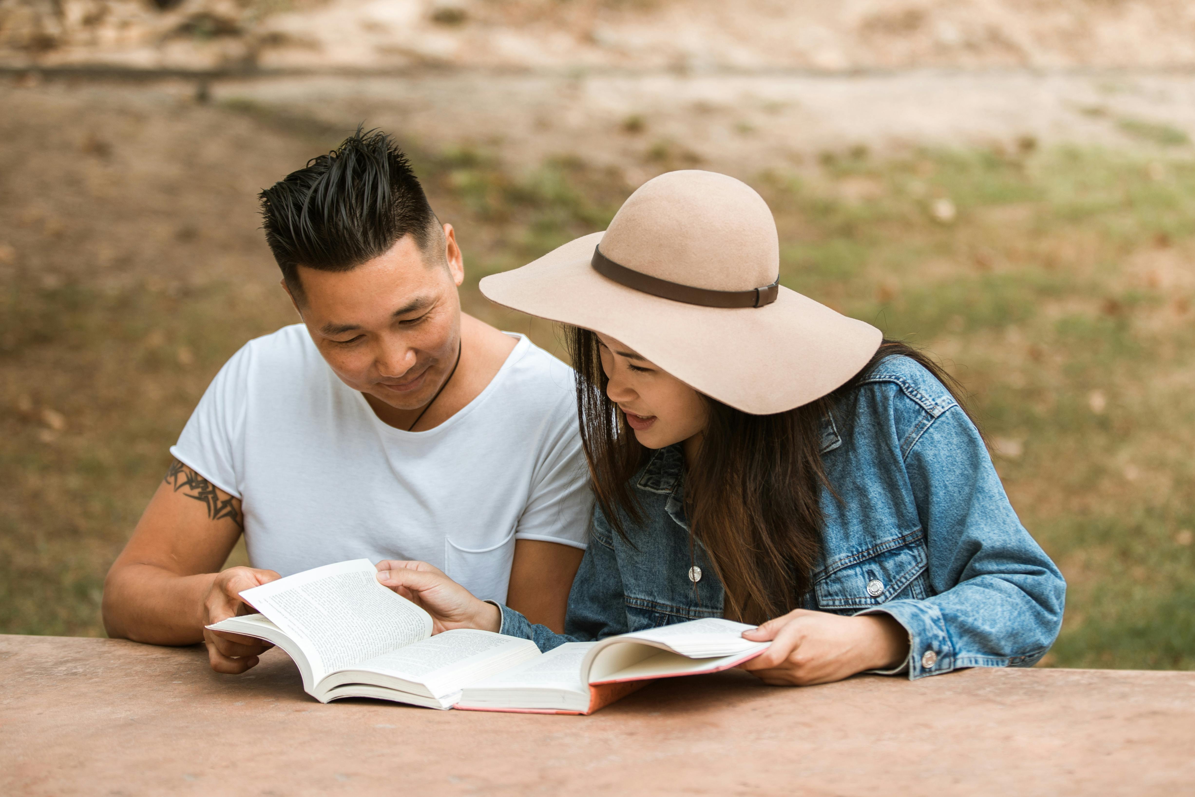Couple Reading Book on a Picnic · Free Stock Photo