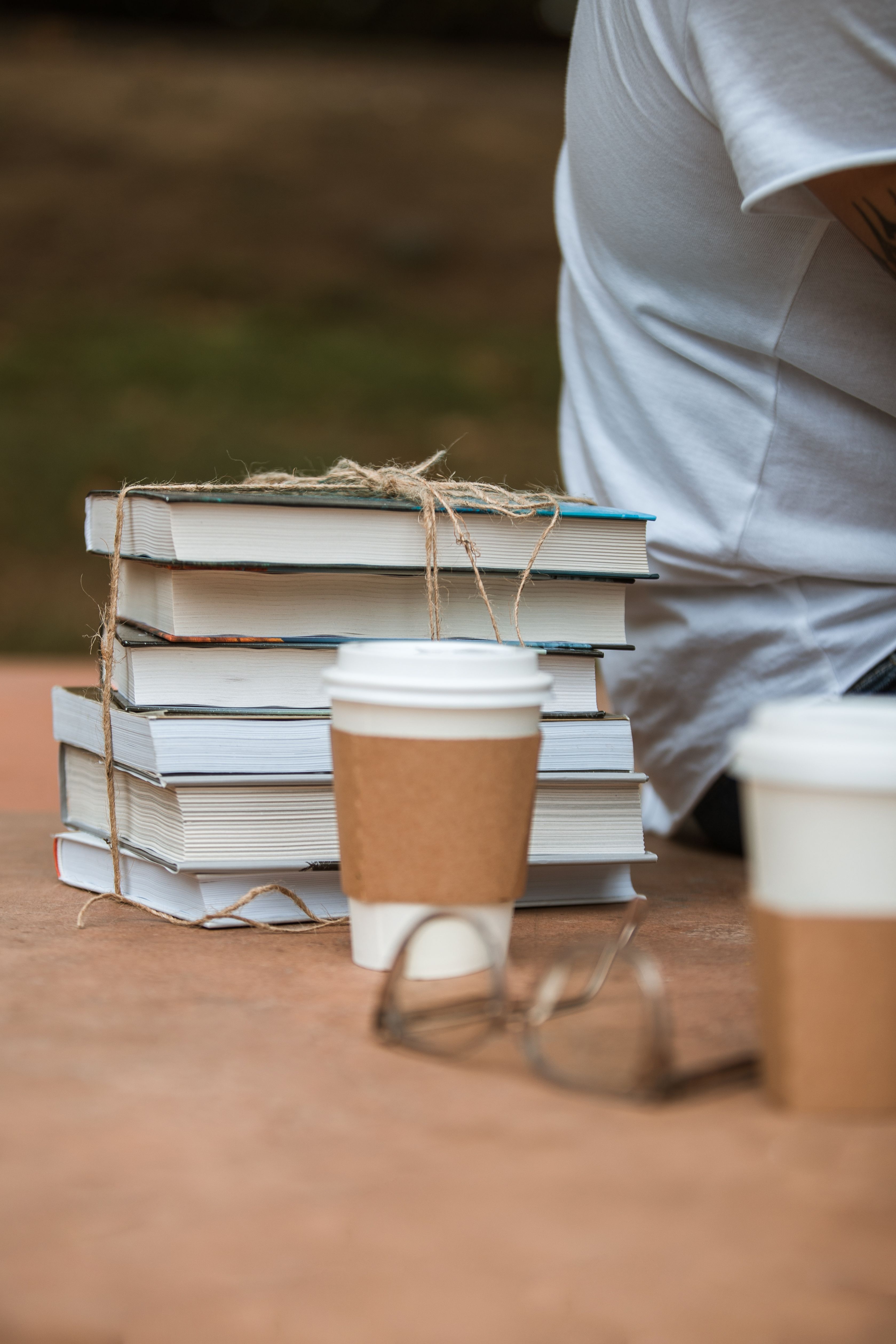 Eyeglasses by Paper Cups and Books · Free Stock Photo