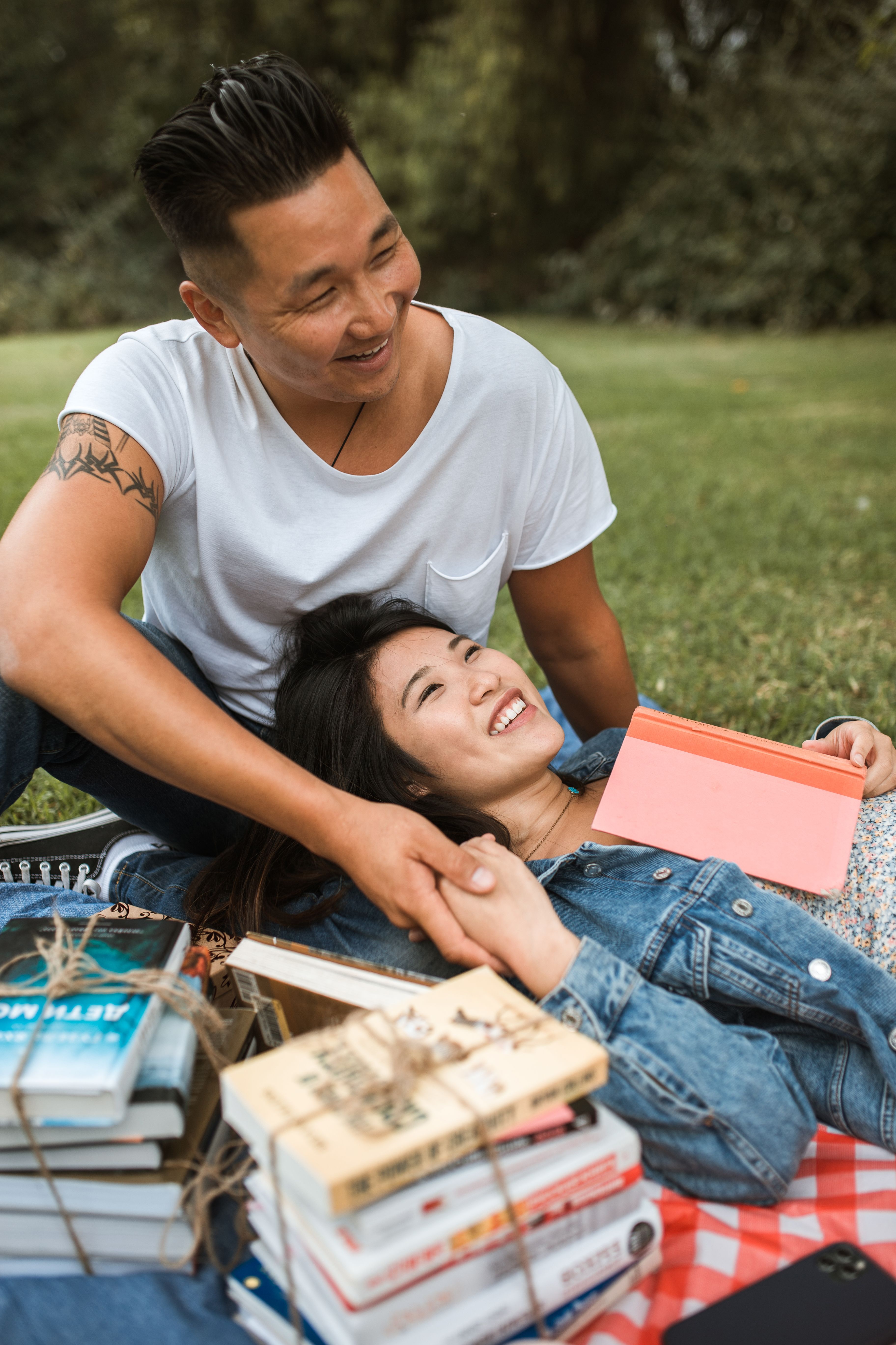 A Couple in a Meadow with Books · Free Stock Photo