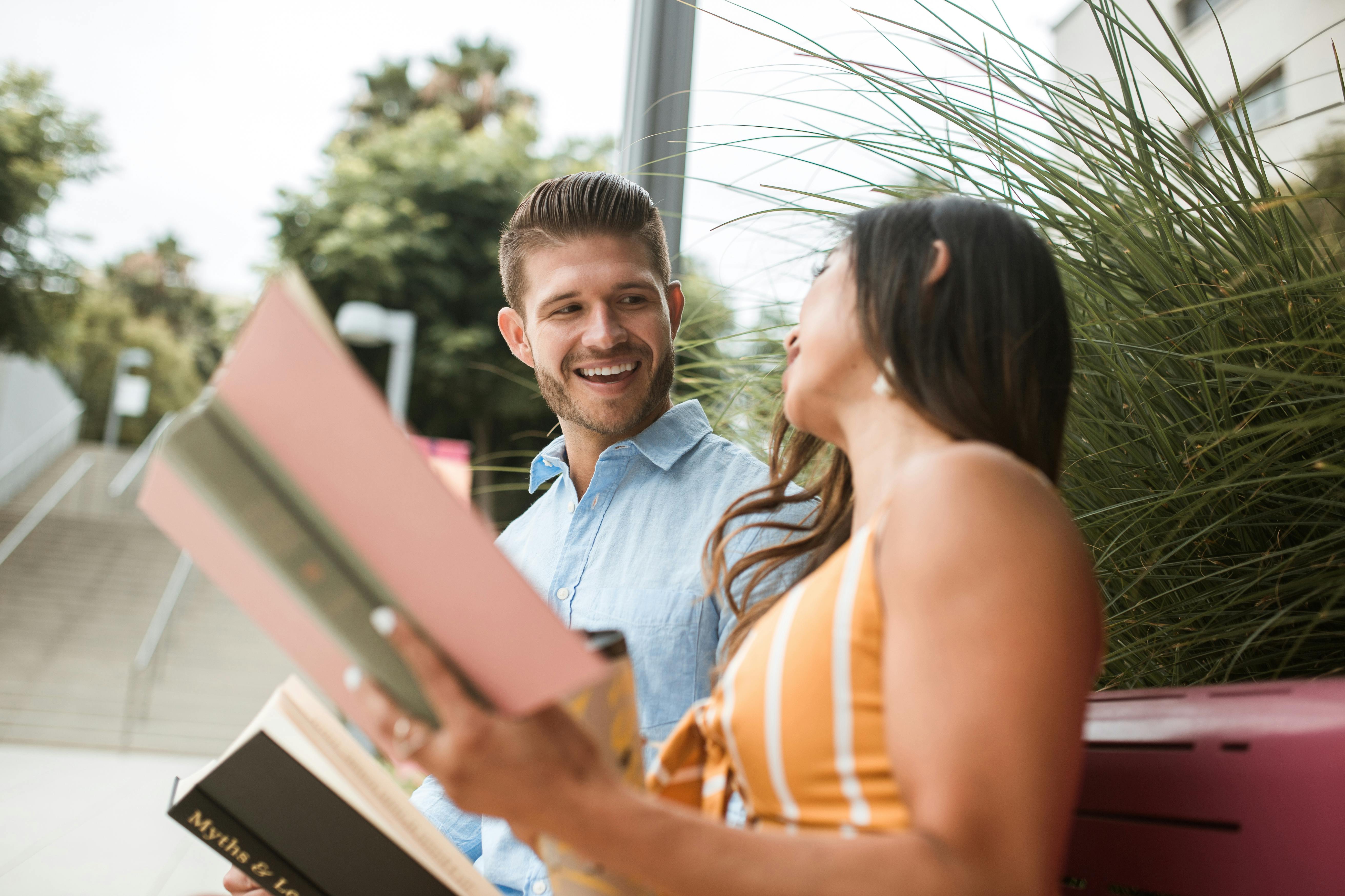 A Happy Couple Holding Books · Free Stock Photo