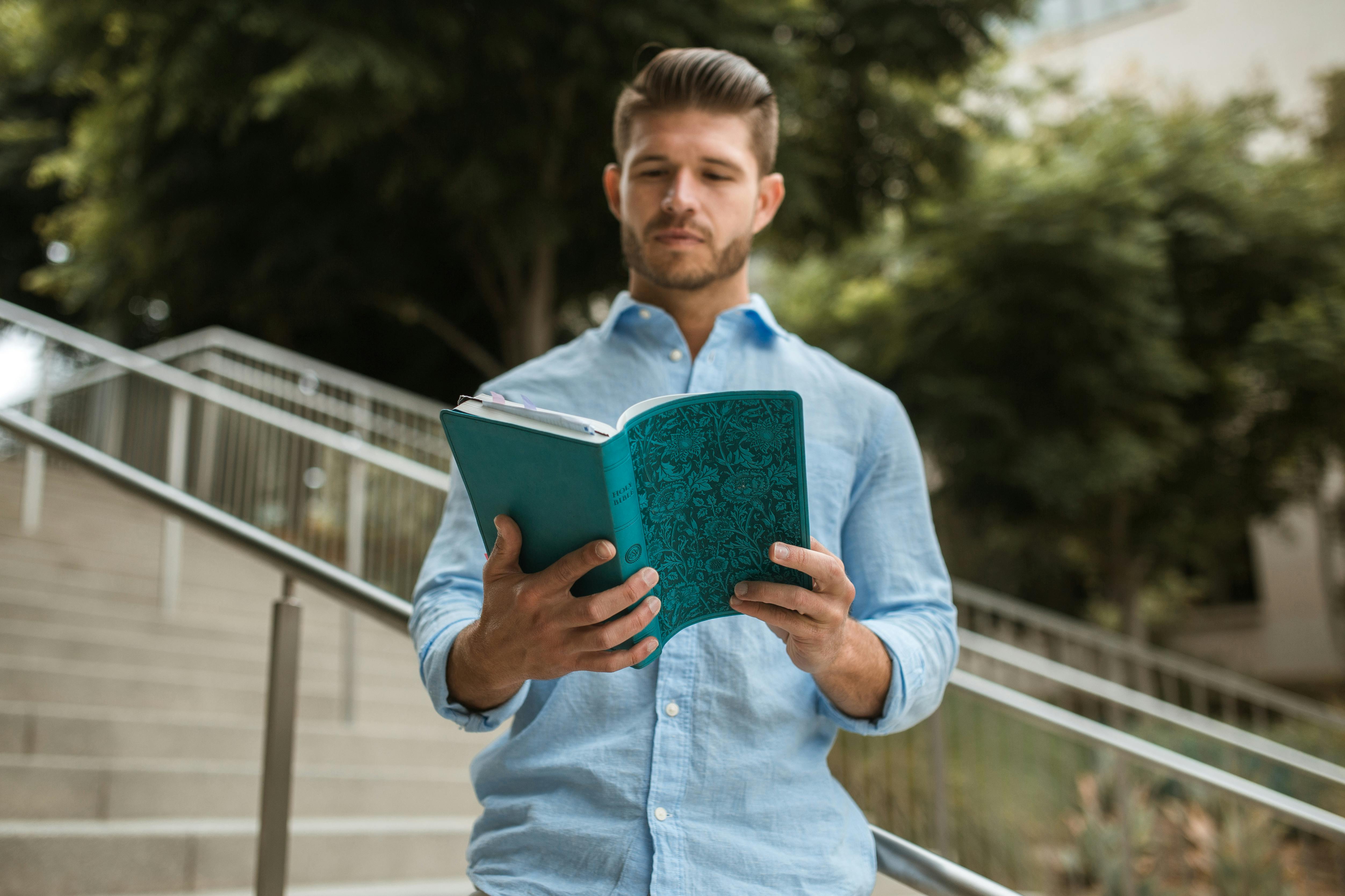 Man in Blue Long Sleeves Shirt Reading Book · Free Stock Photo
