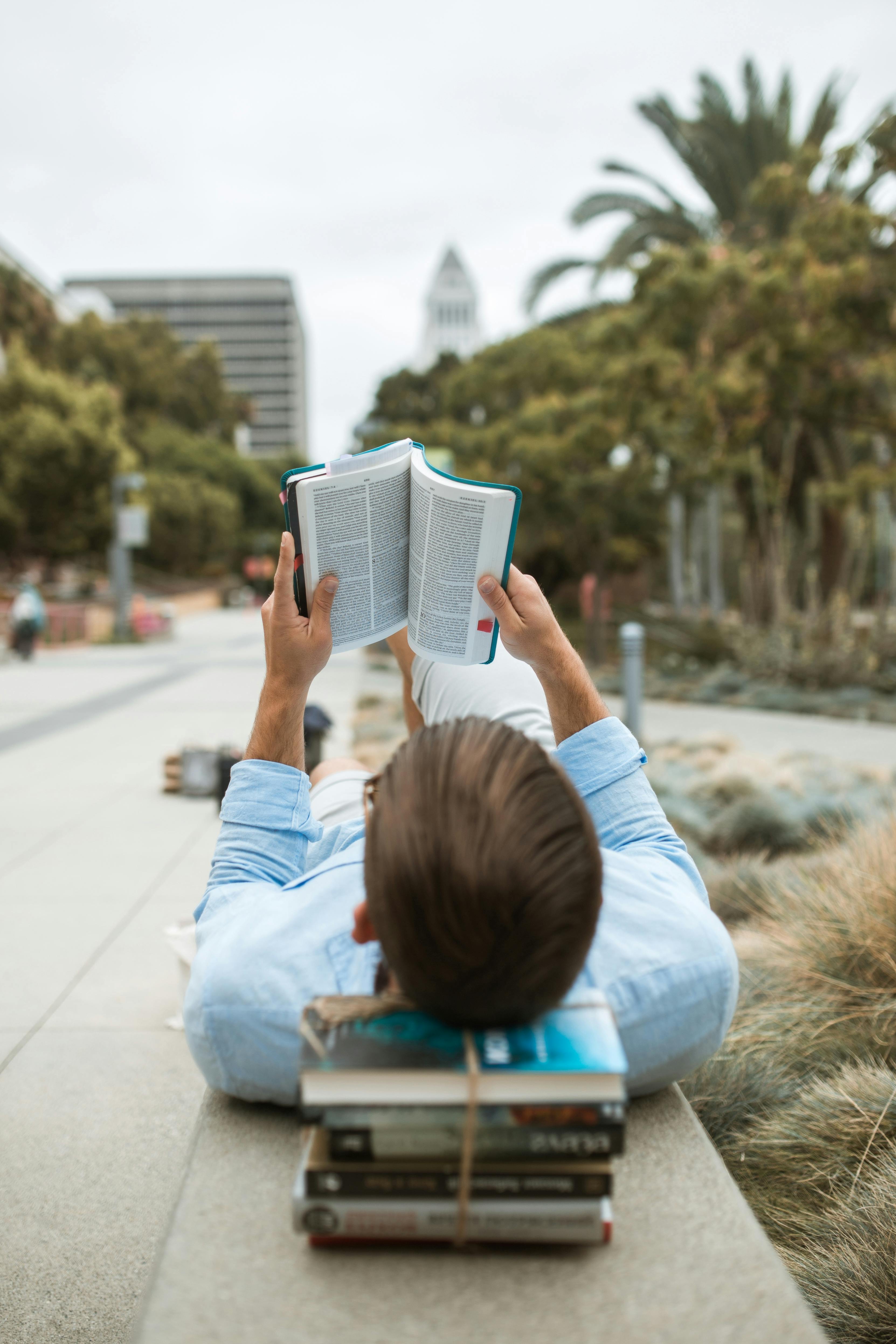 Person Reading Book on Beach · Free Stock Photo