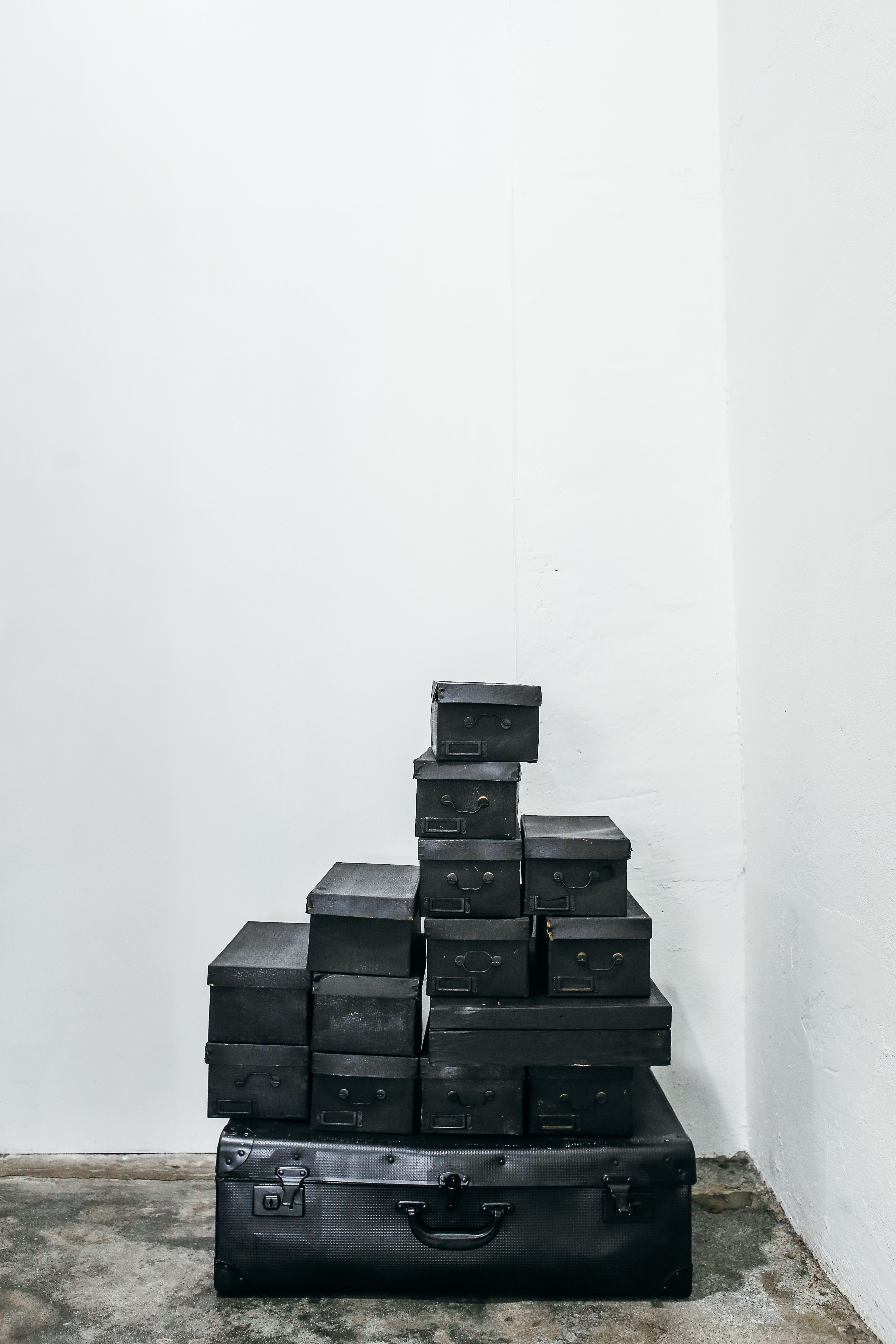 Stacks of Black Boxes on Black Suitcase · Free Stock Photo