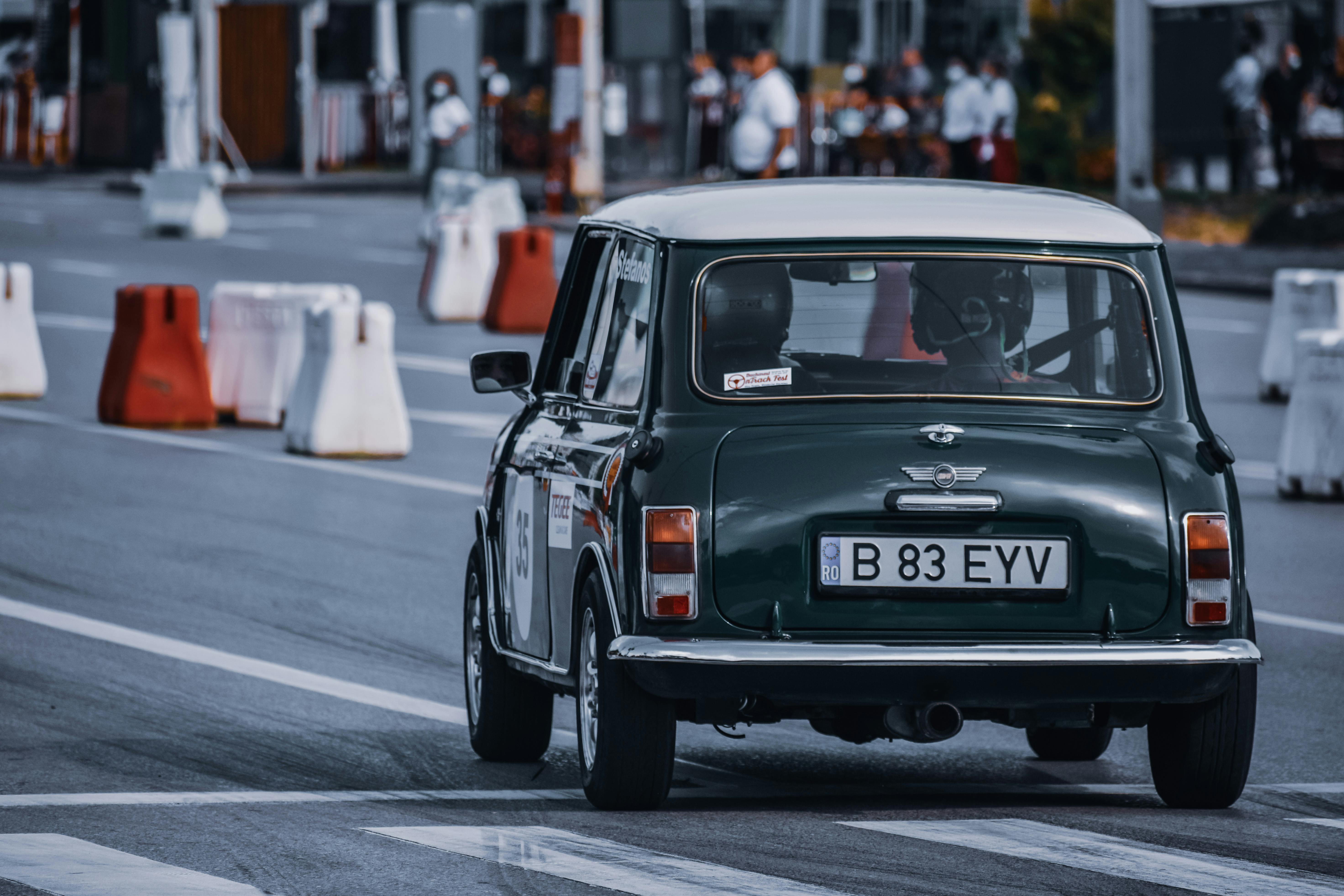 Retro car driving on asphalt road with marking lines · Free Stock Photo