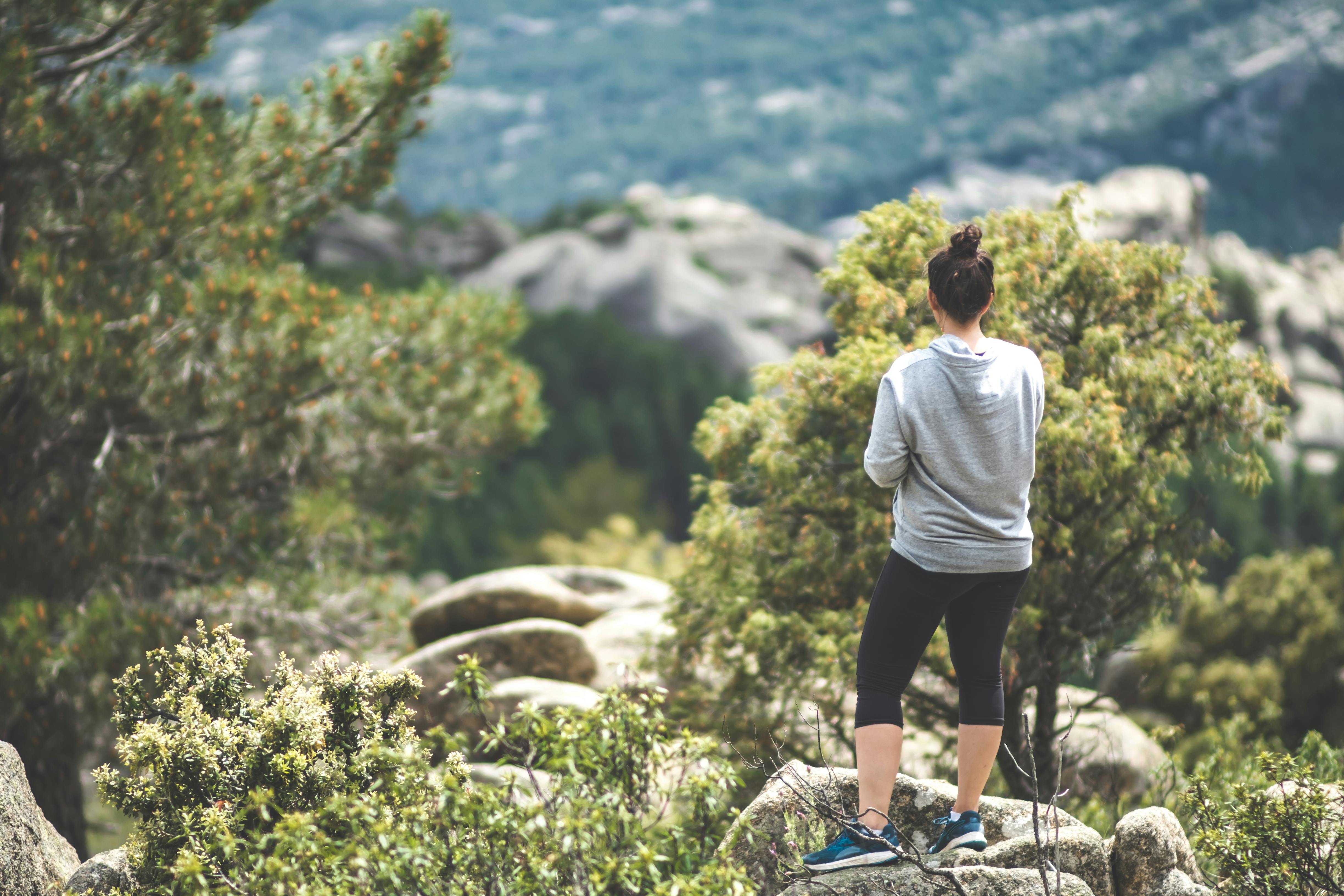 Woman Standing on a Rock in the Mountains · Free Stock Photo