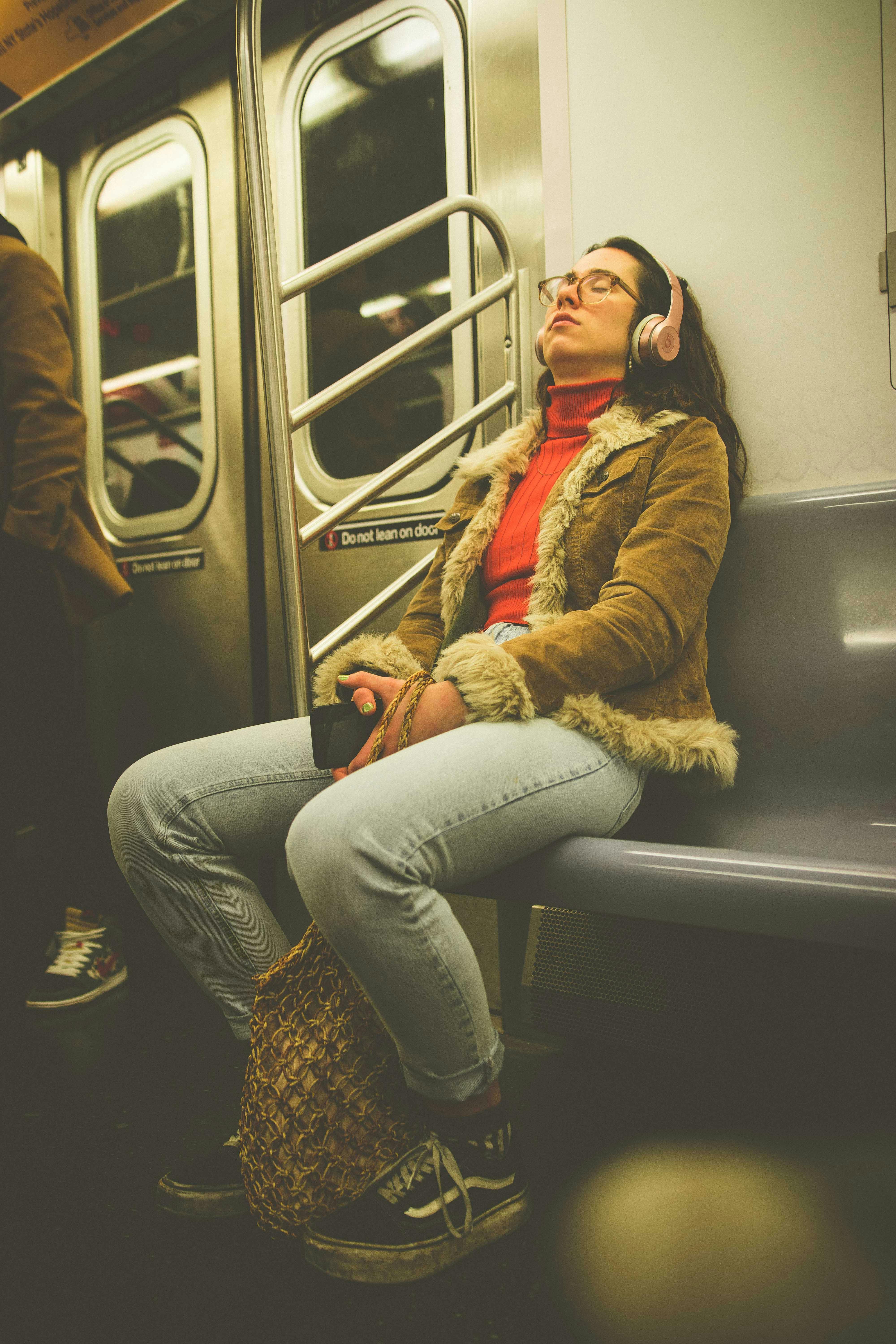 Woman in Brown Jacket Sitting in the Train · Free Stock Photo