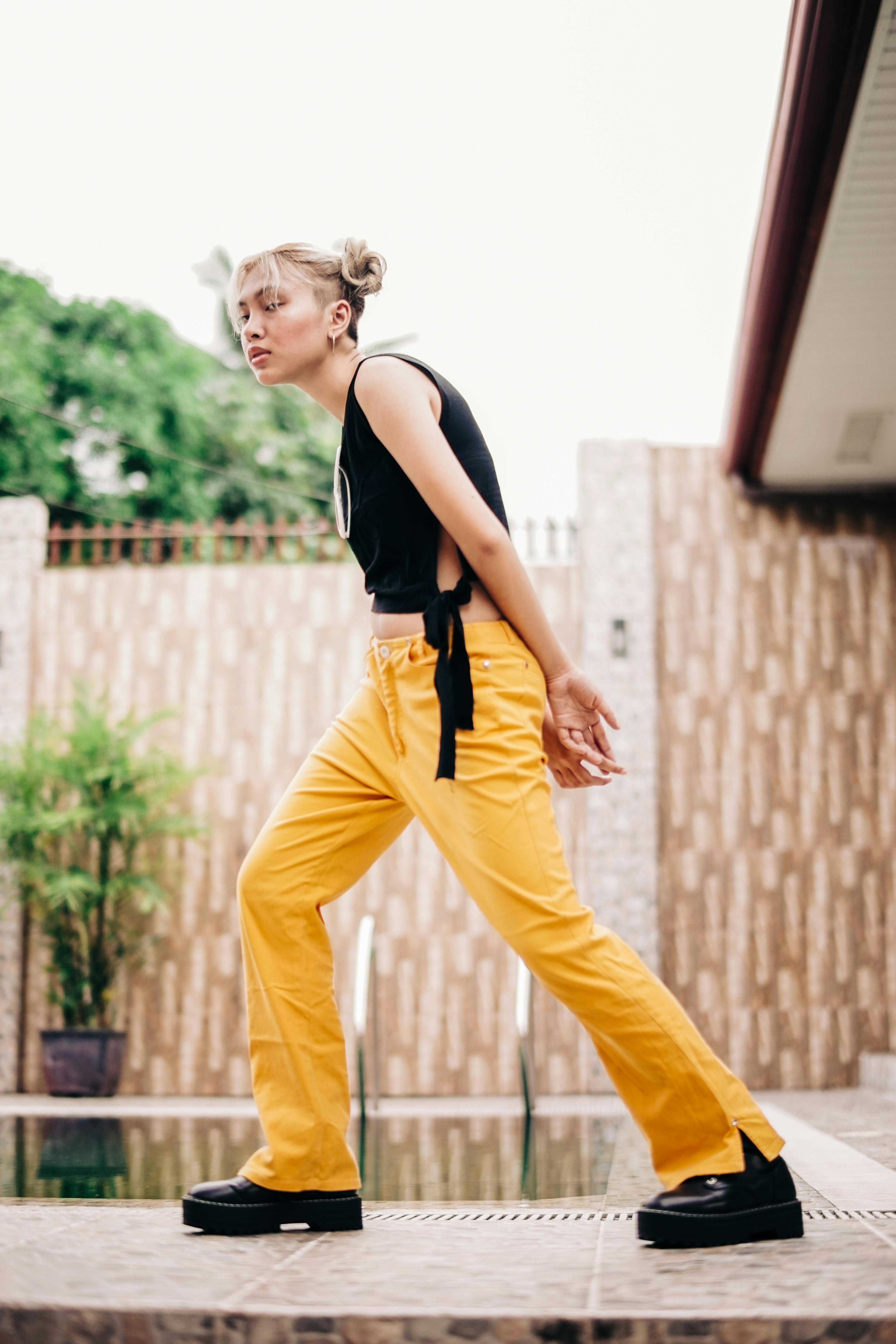 A Young Woman Modeling in a Trendy Outfit · Free Stock Photo